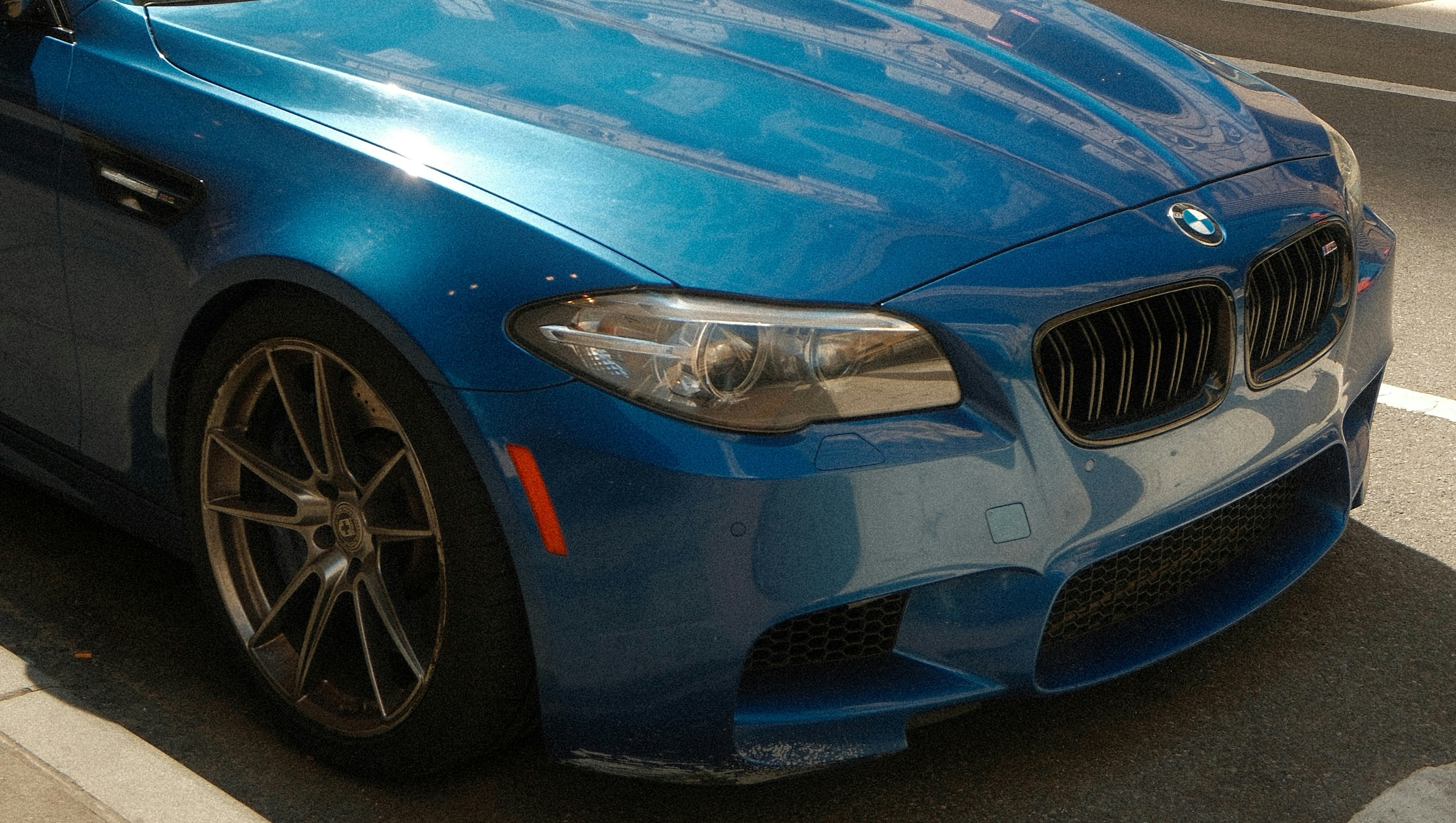 Blue BMW Frontal in Afternoon Light