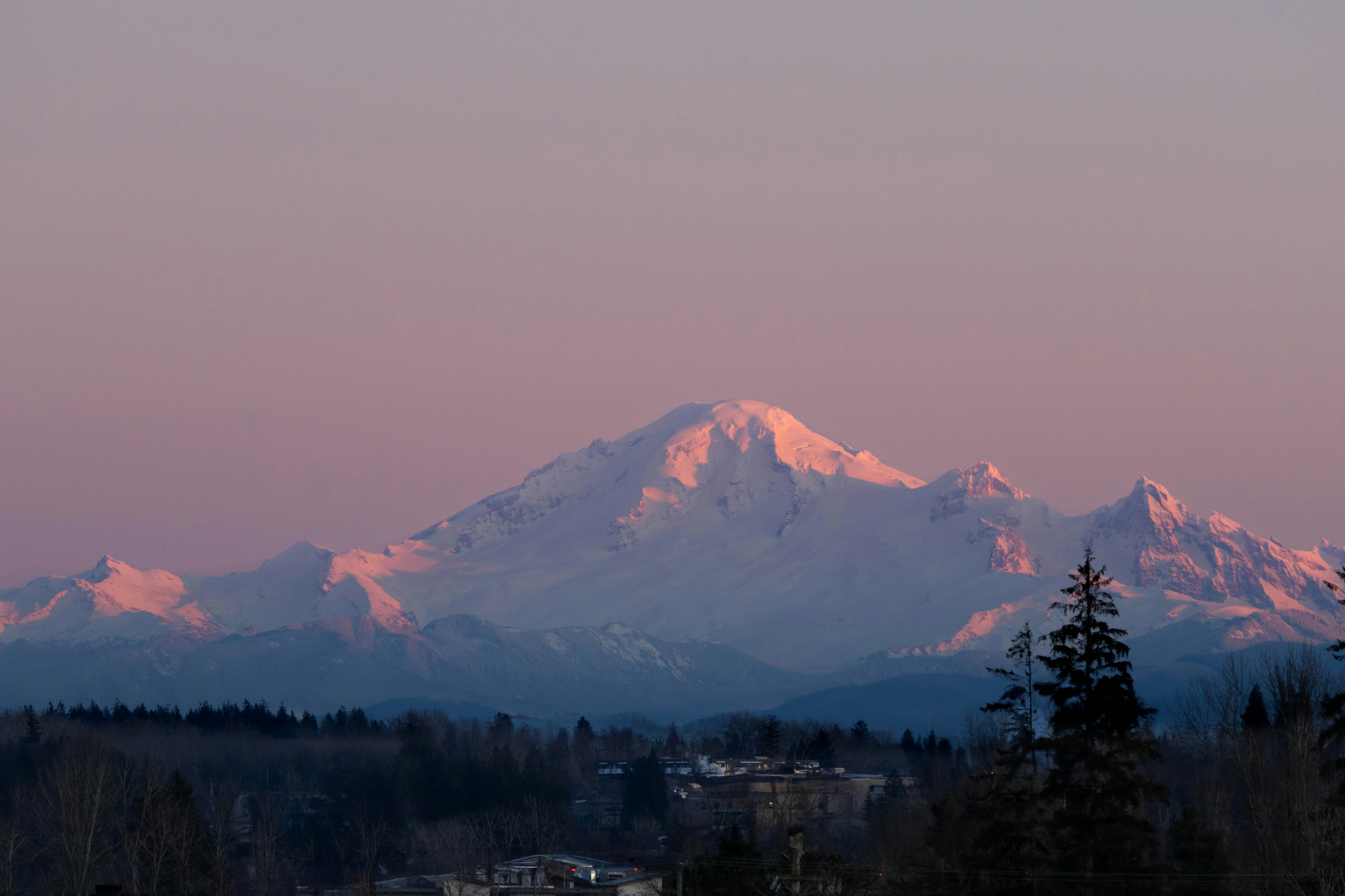 Pink-tinged Peak: Dawn Light over Snow-capped Range