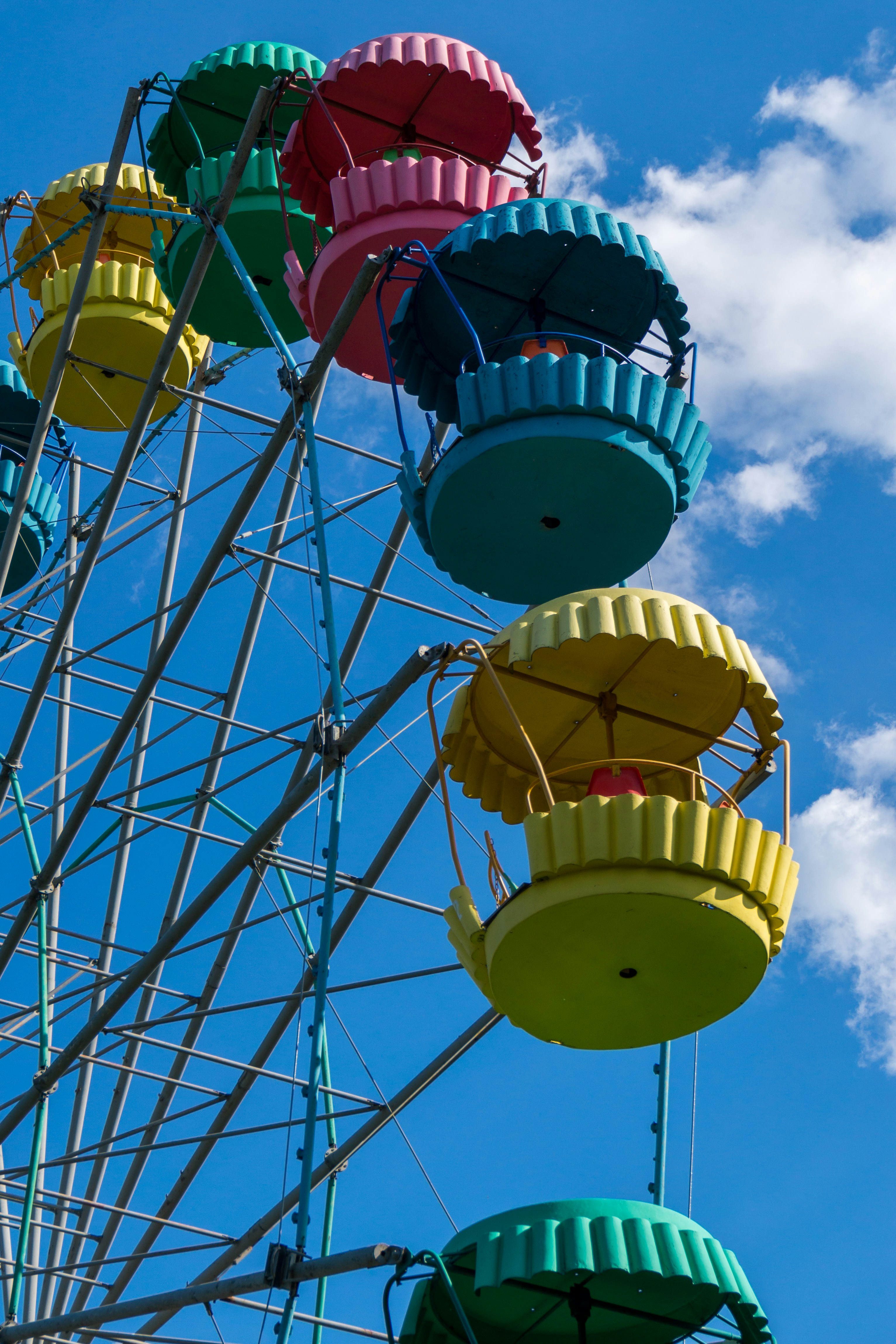 Spinful Skies: A Colorful Ferris Wheel Reaches for the Blue
