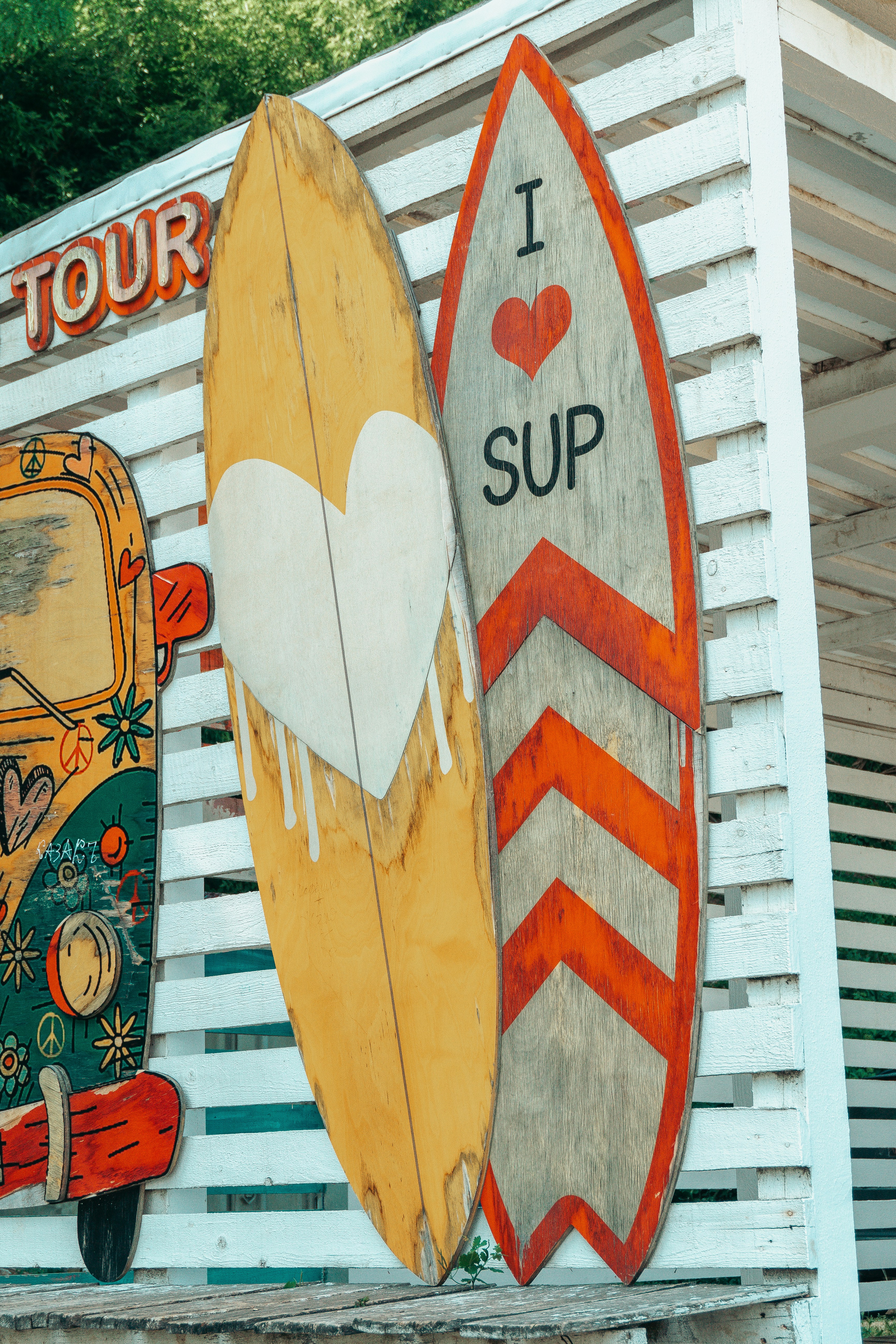 Heart on Wood: Surfboards Lean Against a Louvered Shorefront