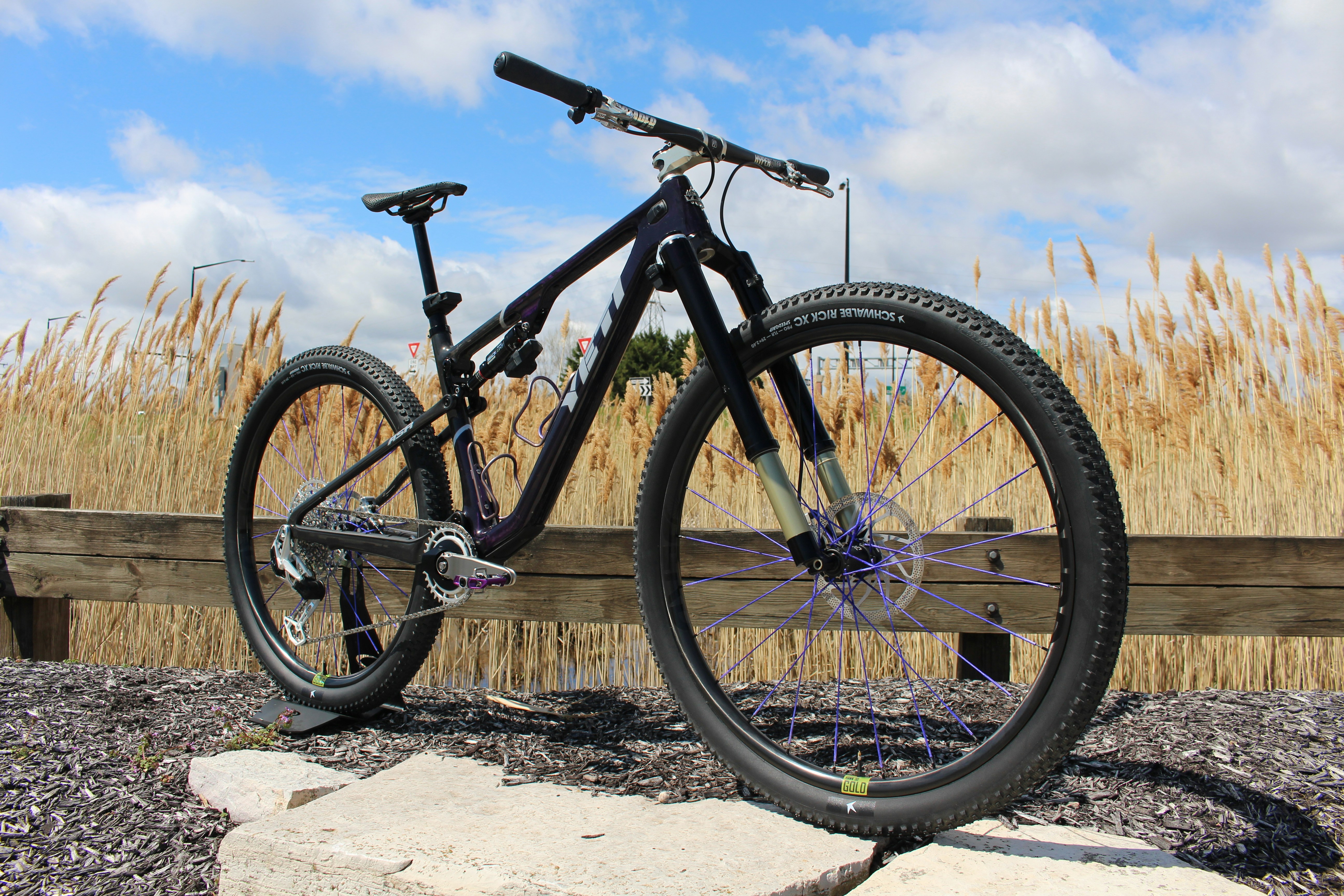 Black Mountain Bike Resting on Gravel, Sunset Field