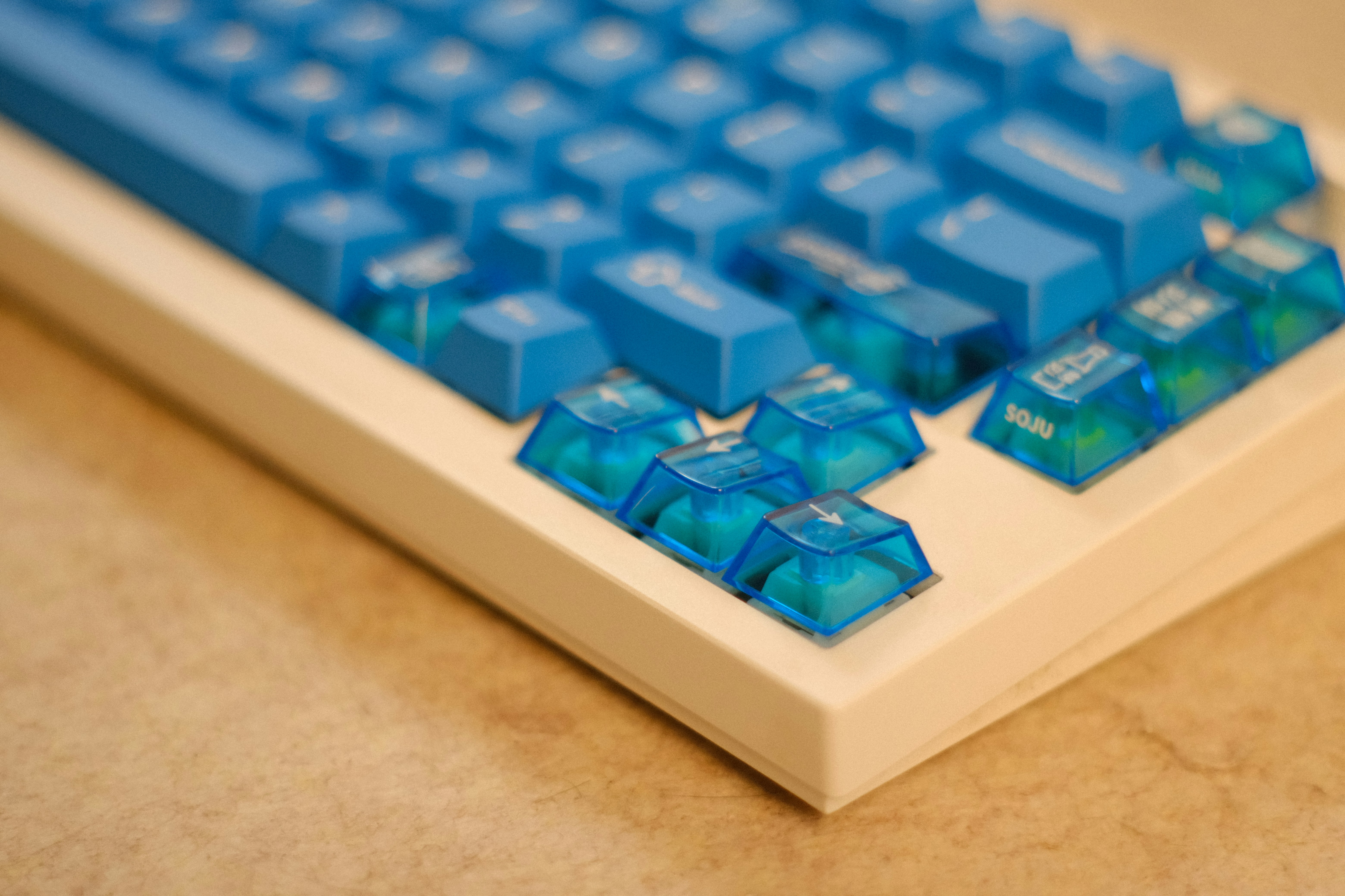 Blue Keys in Focus: Retro Keyboard Details on a Warm Surface
