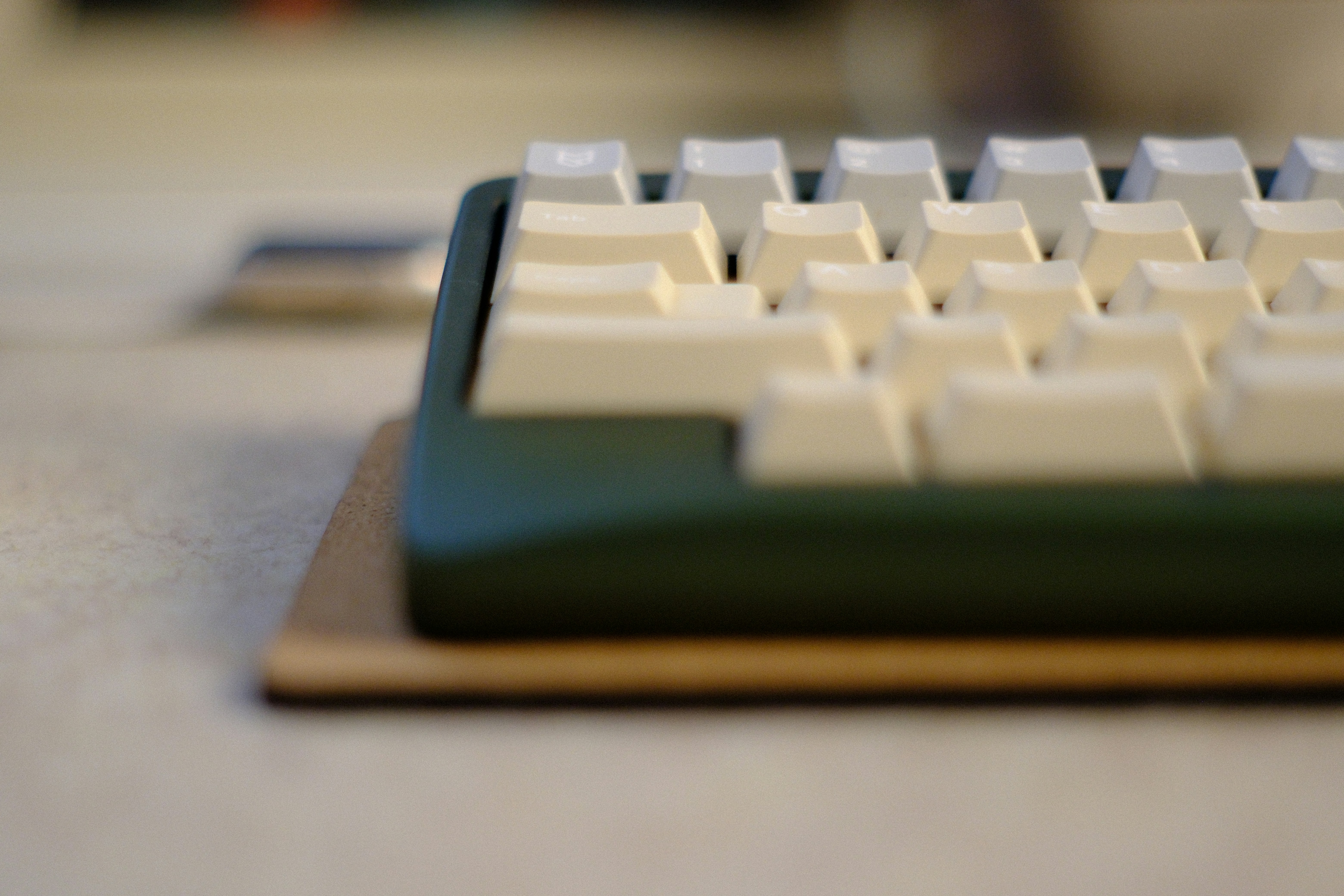 Close-Up of a Mechanical Keyboard Edge Resting on a Pad