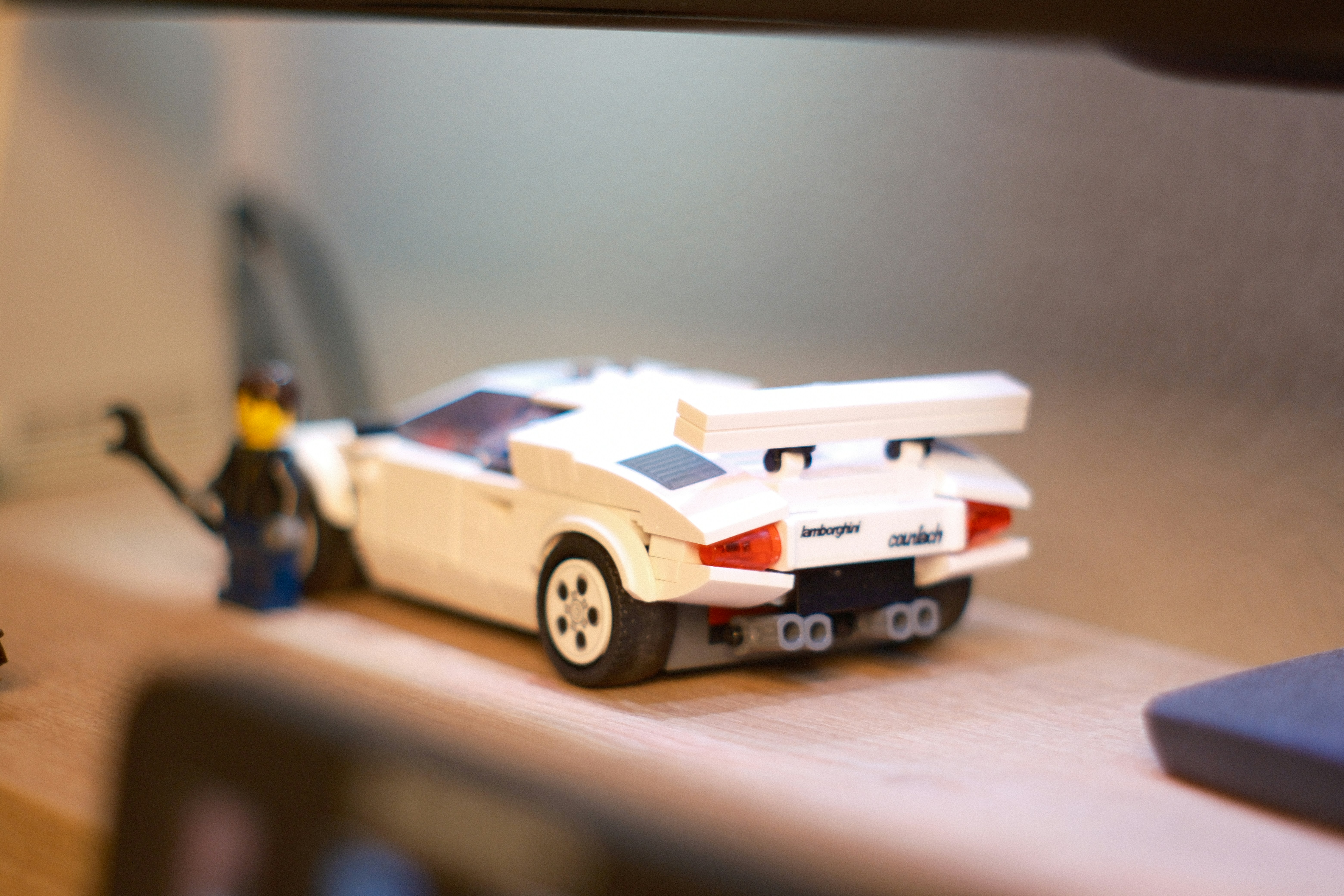 White LEGO Porsche in a Soft-Focused Shelf Scene