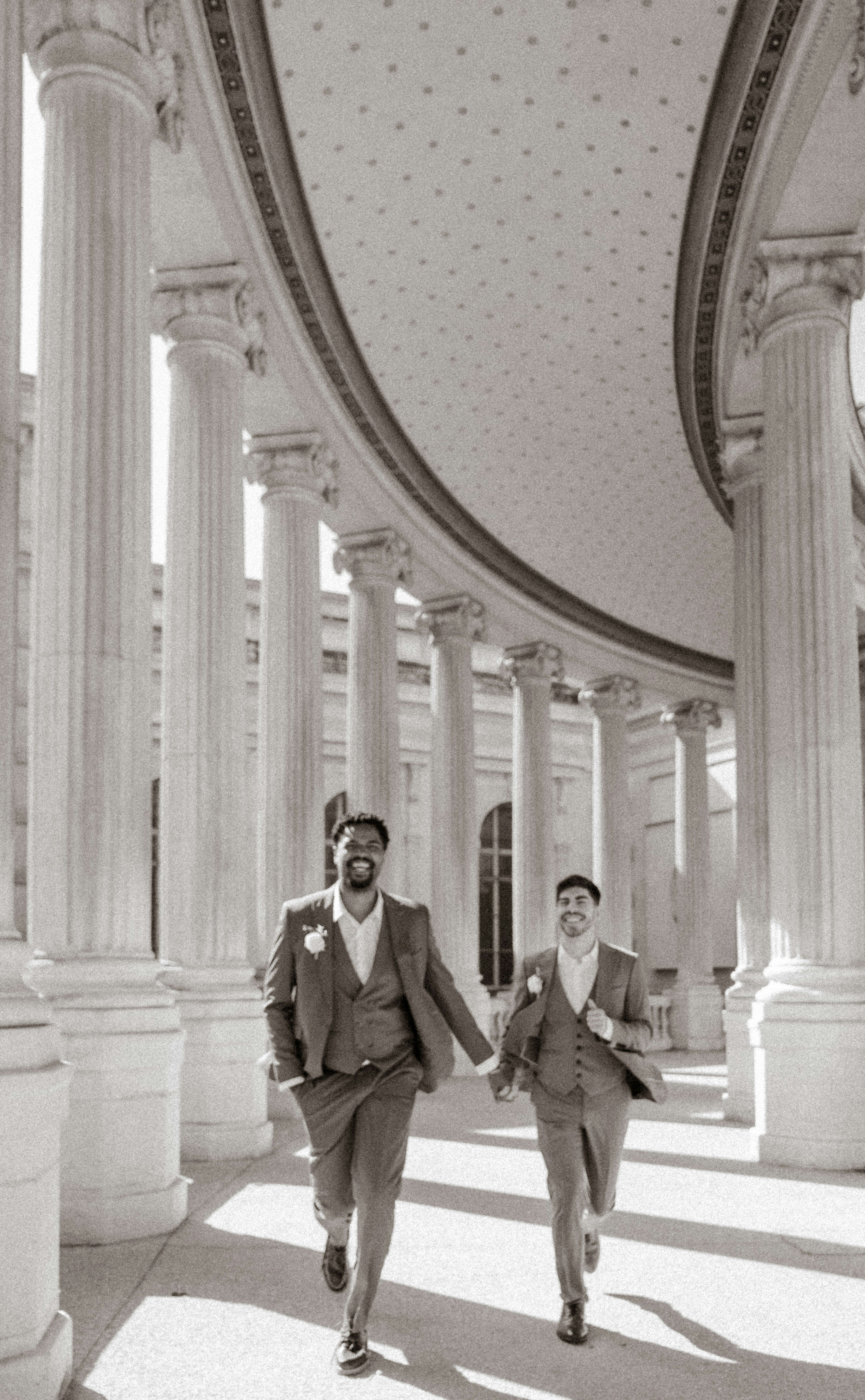 Two Grooms in a classical colonnade