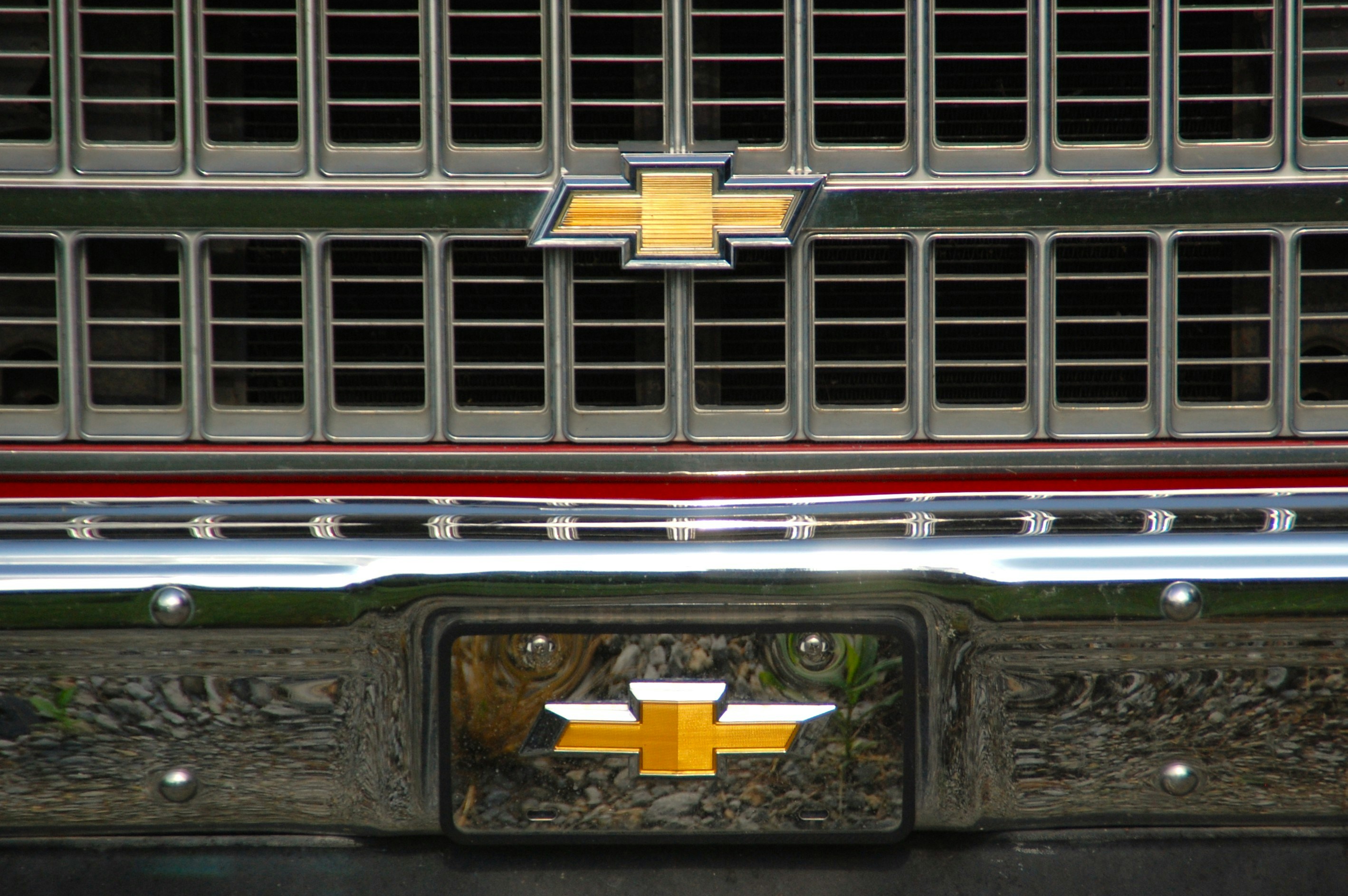 Chevrolet Emblem Reflections: A Close-Up of Chrome and Crest