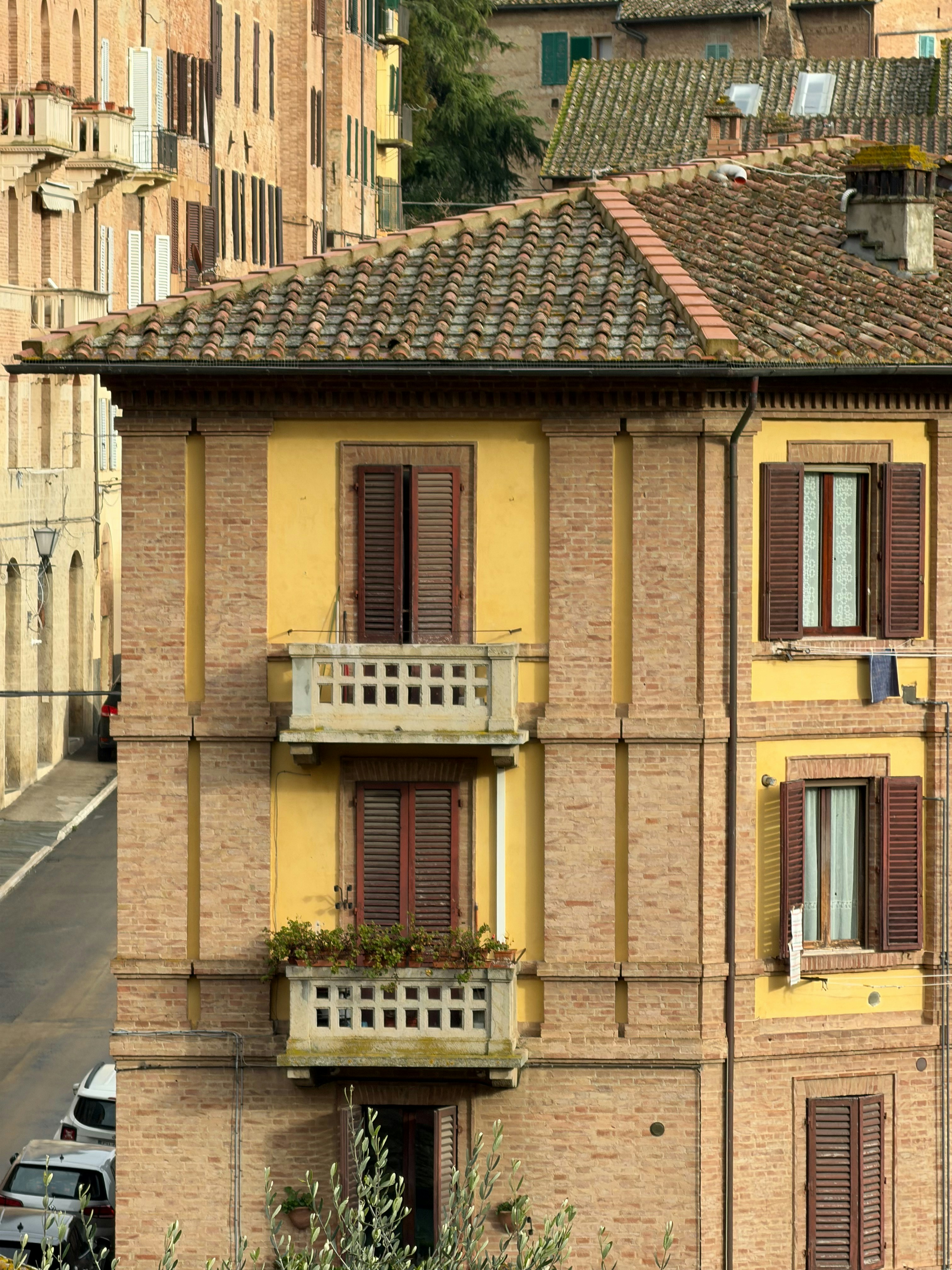Yellow Facade on a Brick Kiln: Balcony Details in Terrace Italian Street