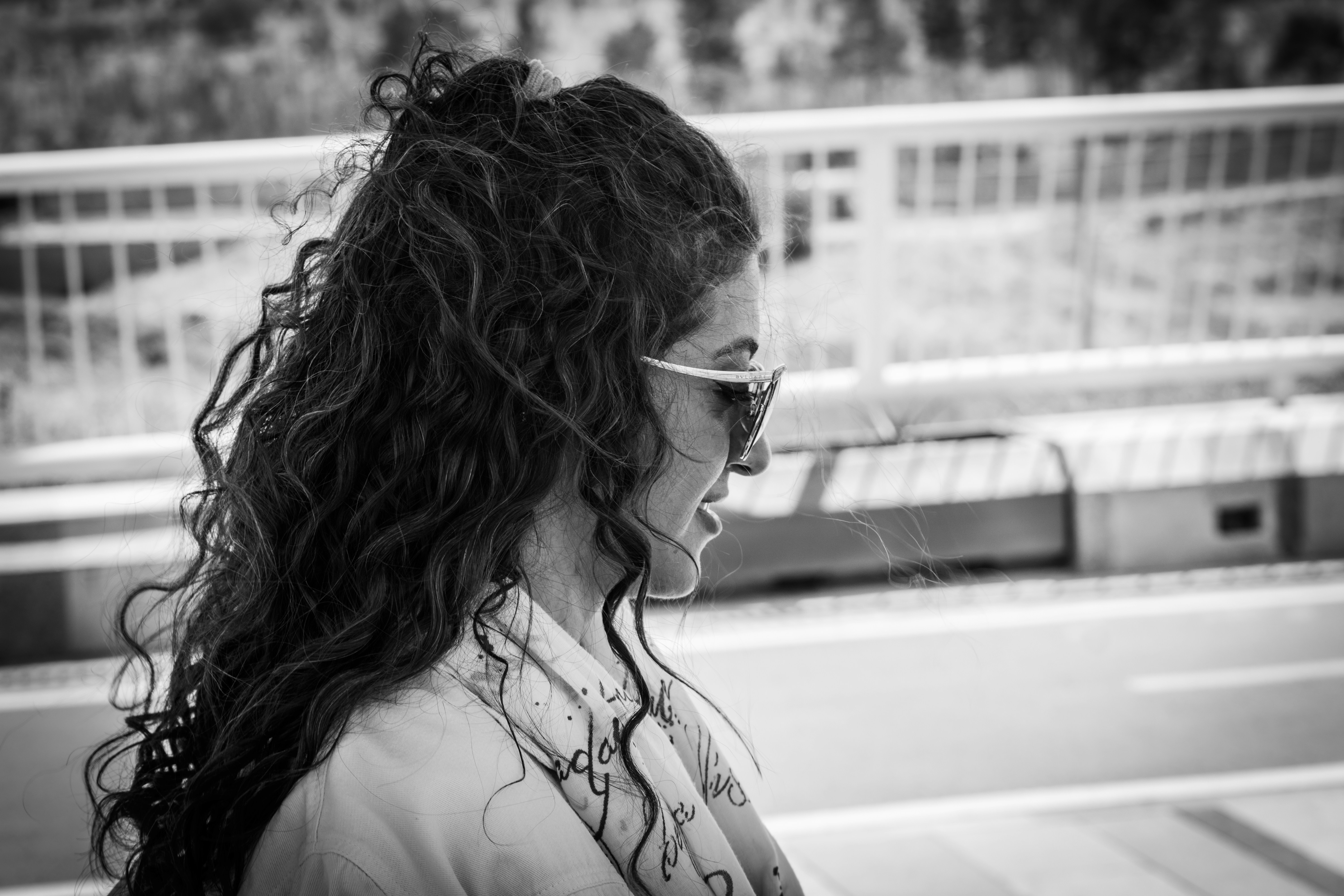 Silhouette in Profile: Portrait of a Woman with Wavy Hair and Sunglasses