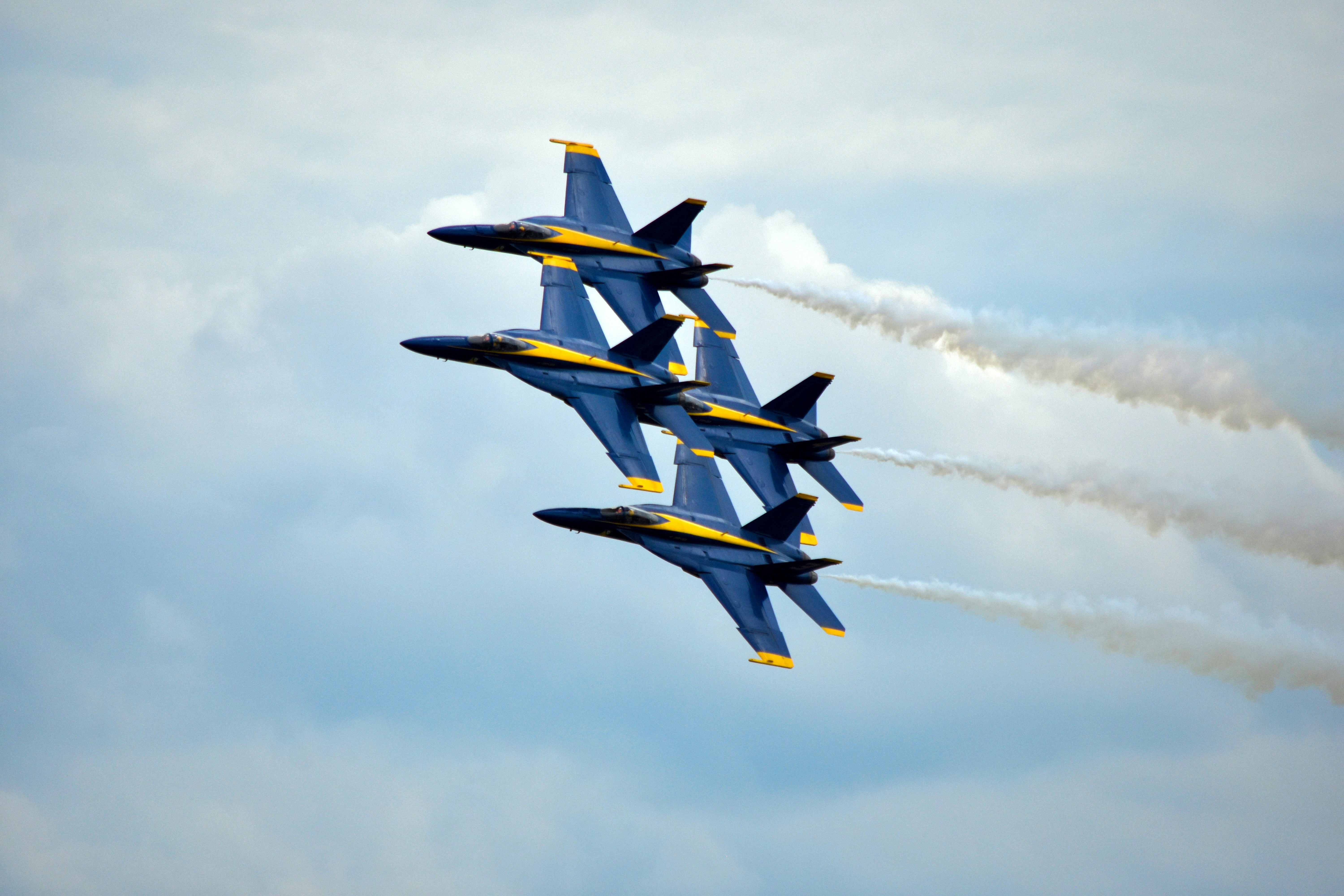 Aerial Quartet: Four Blue F-18-like jets in close formation