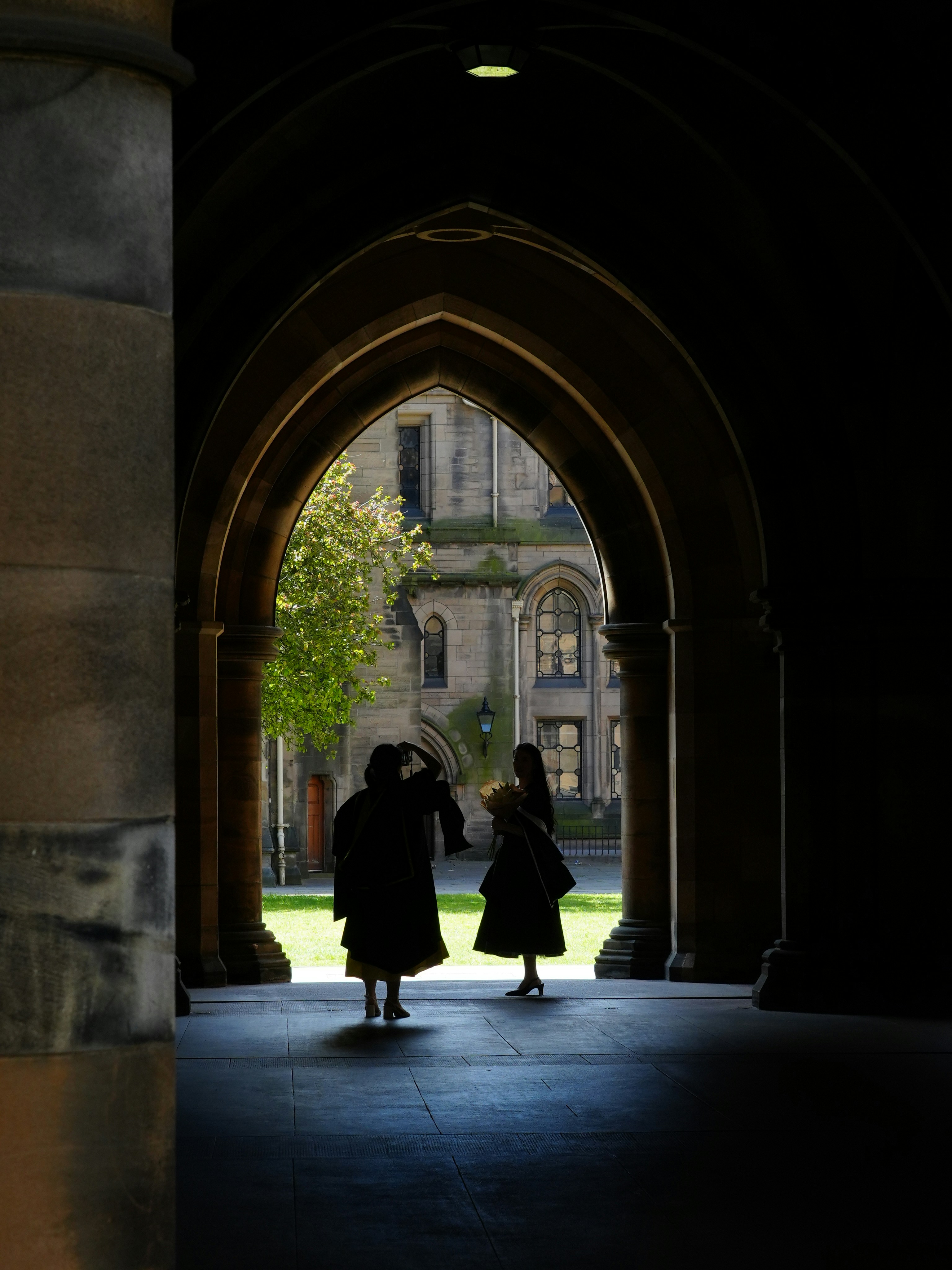 Silhouettes Beneath the Gothic Archway