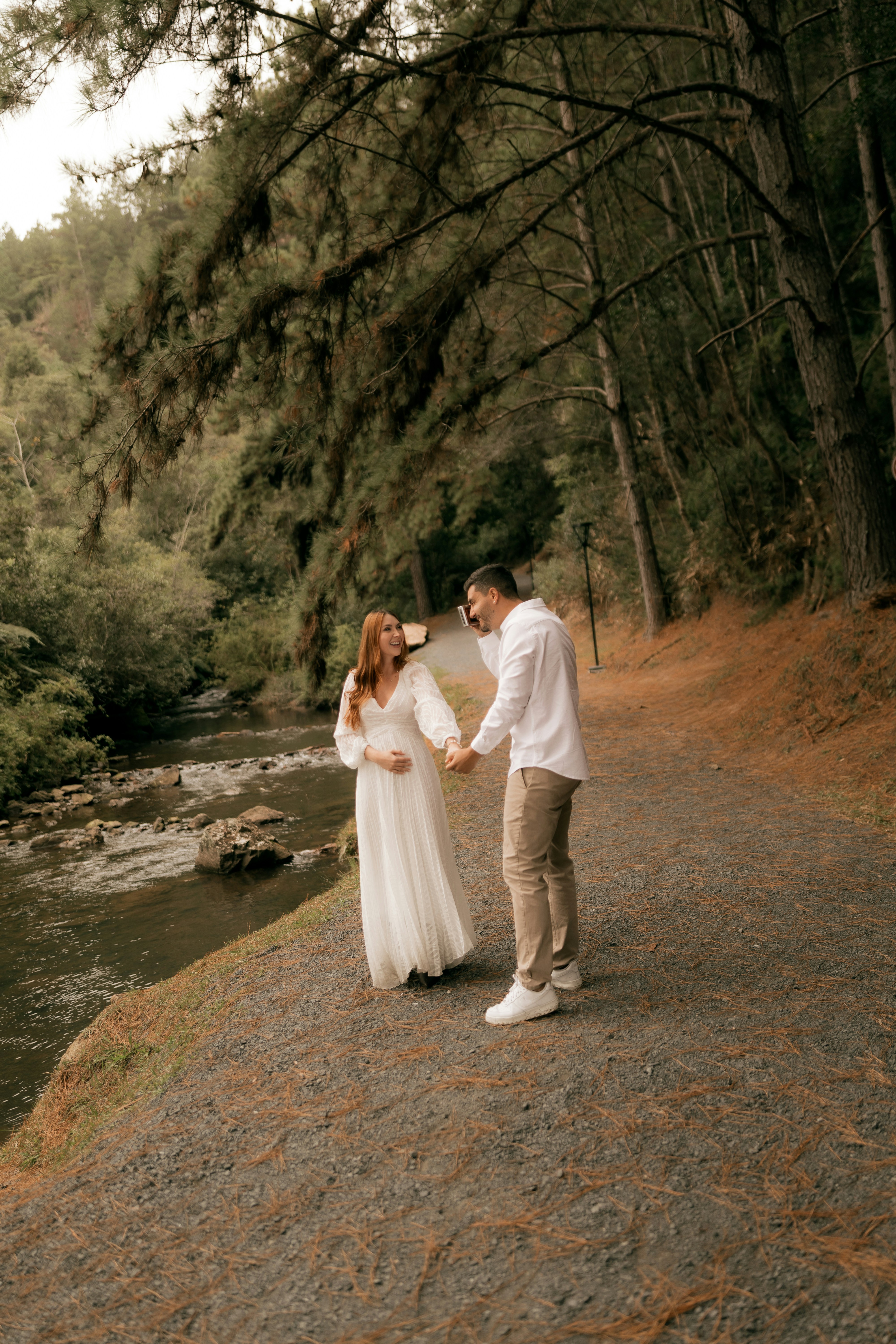 Holding Hands by the River: A Quiet Moment in the Woods
