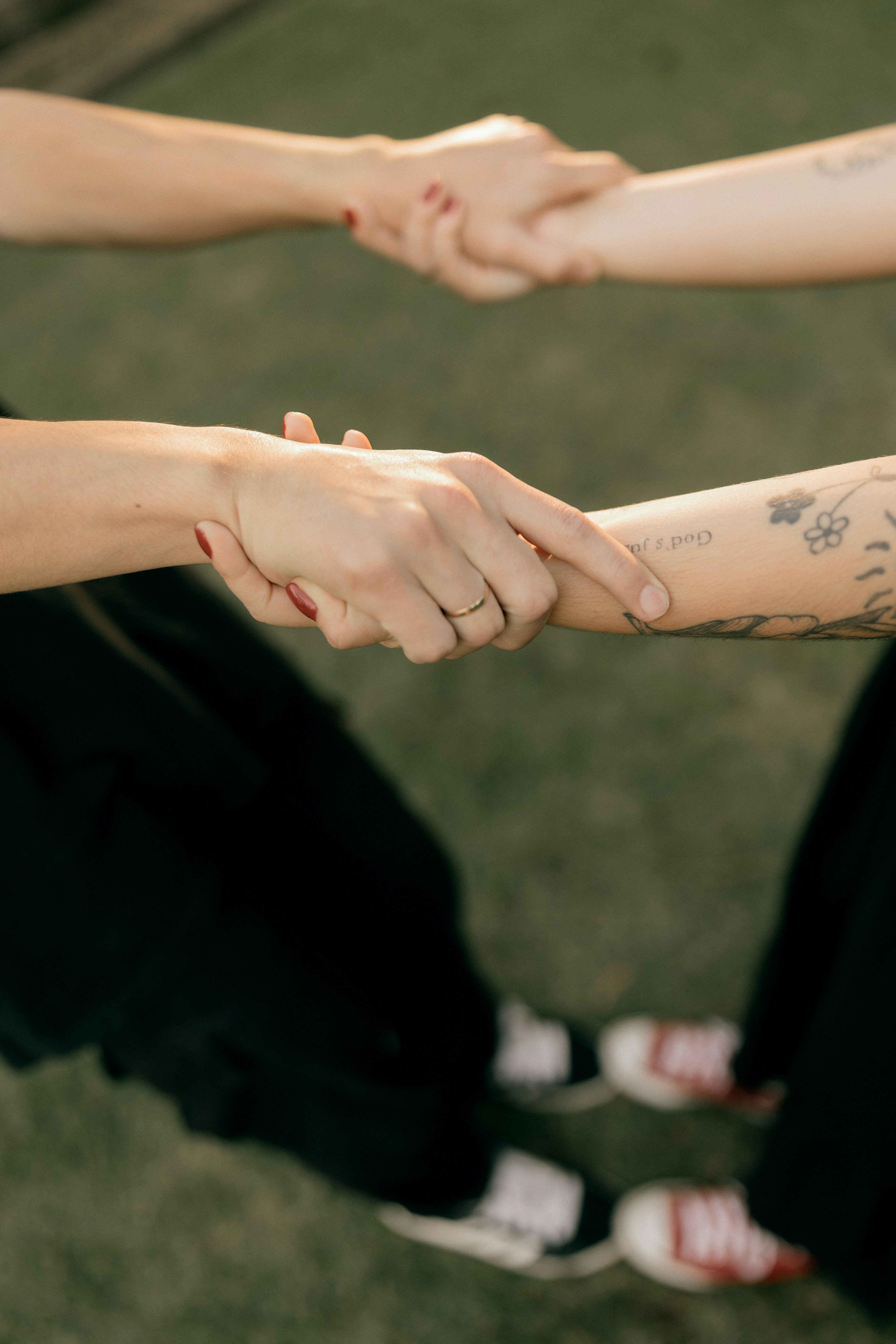 Handshake Across Tattoos: A Moment of Unity on the Field