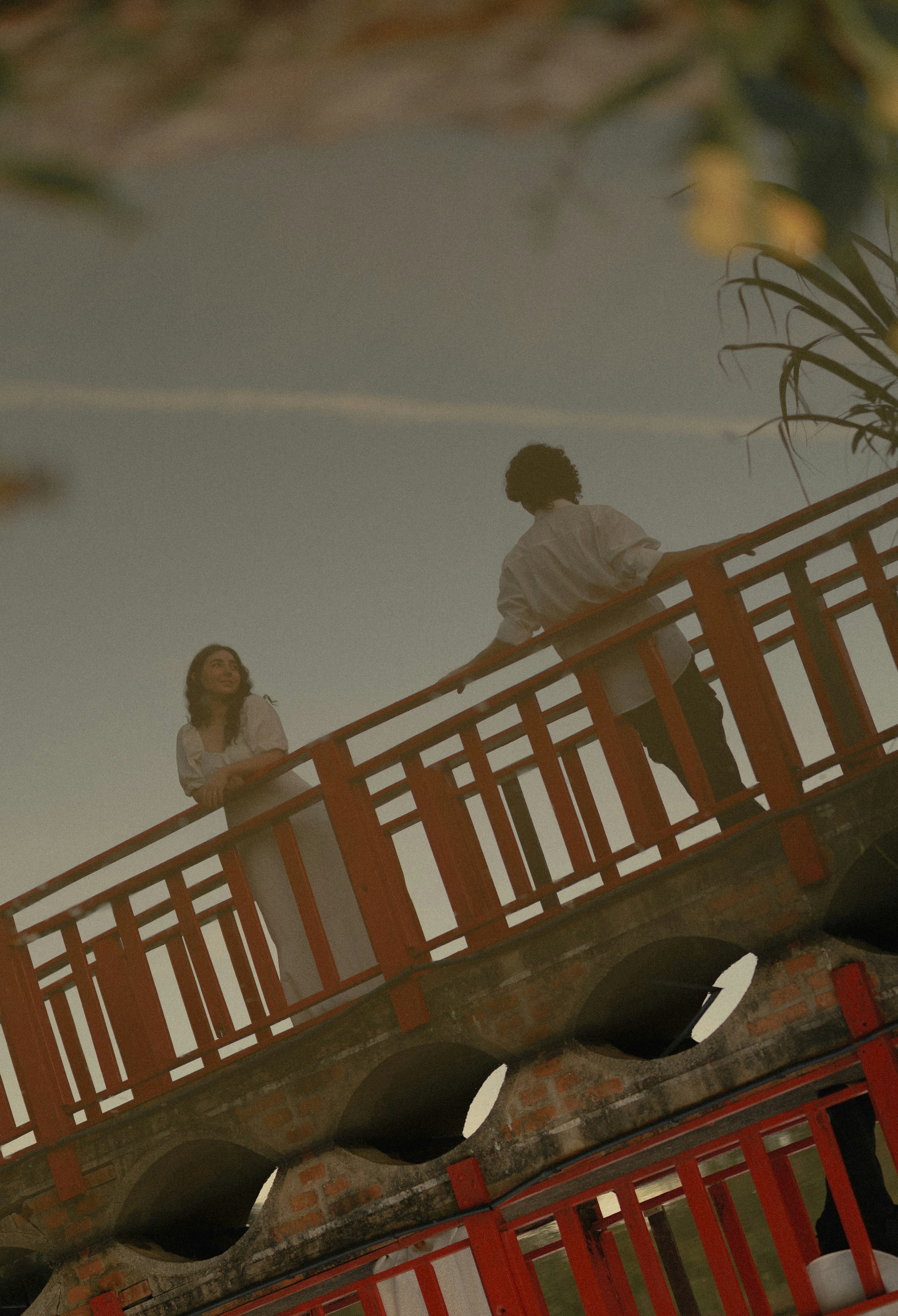 Bridge Moments: A Quiet Conversation Under Tangerine Rails