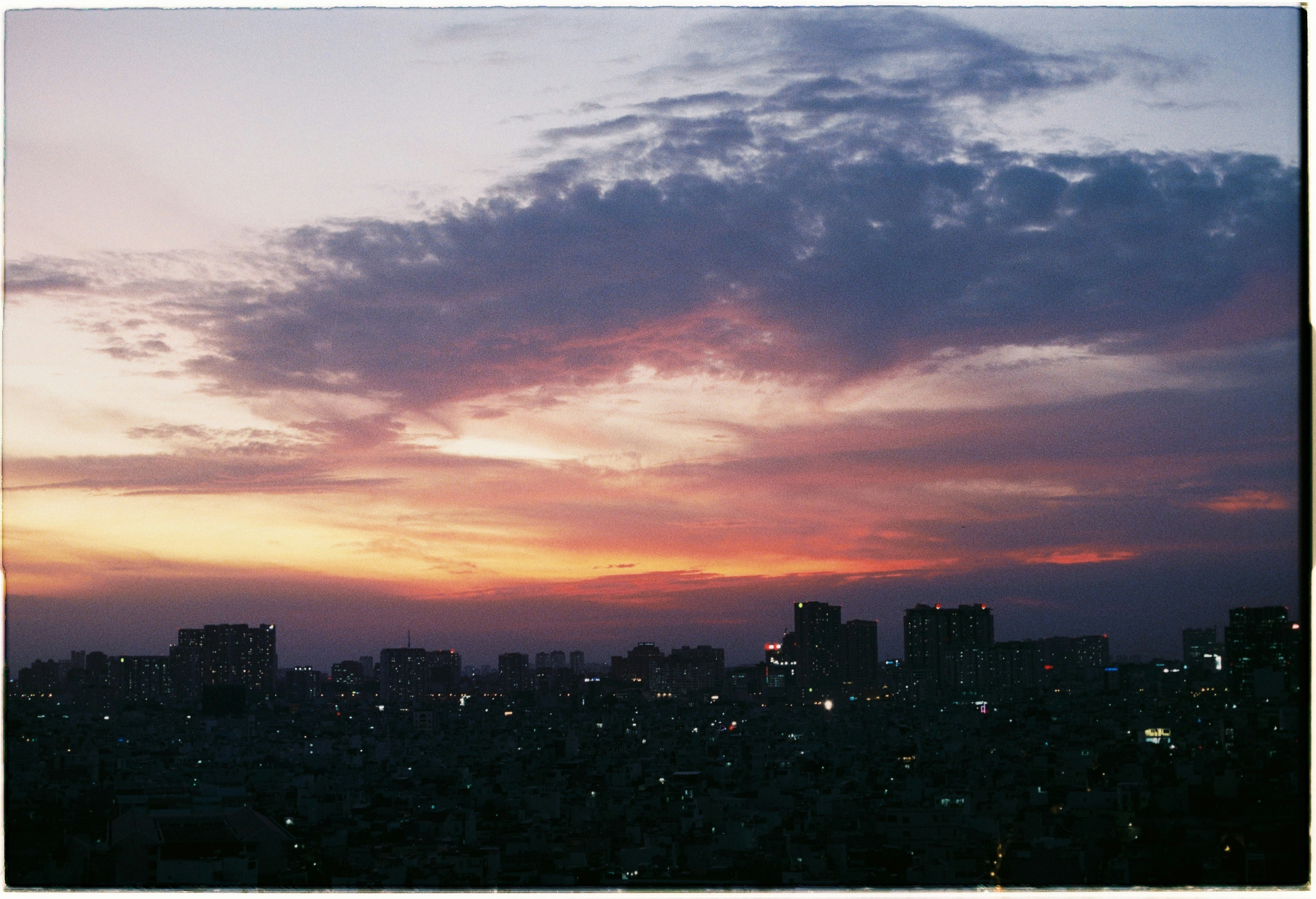 Twilight Skyline: City Silhouette Beneath a Glowing Horizon