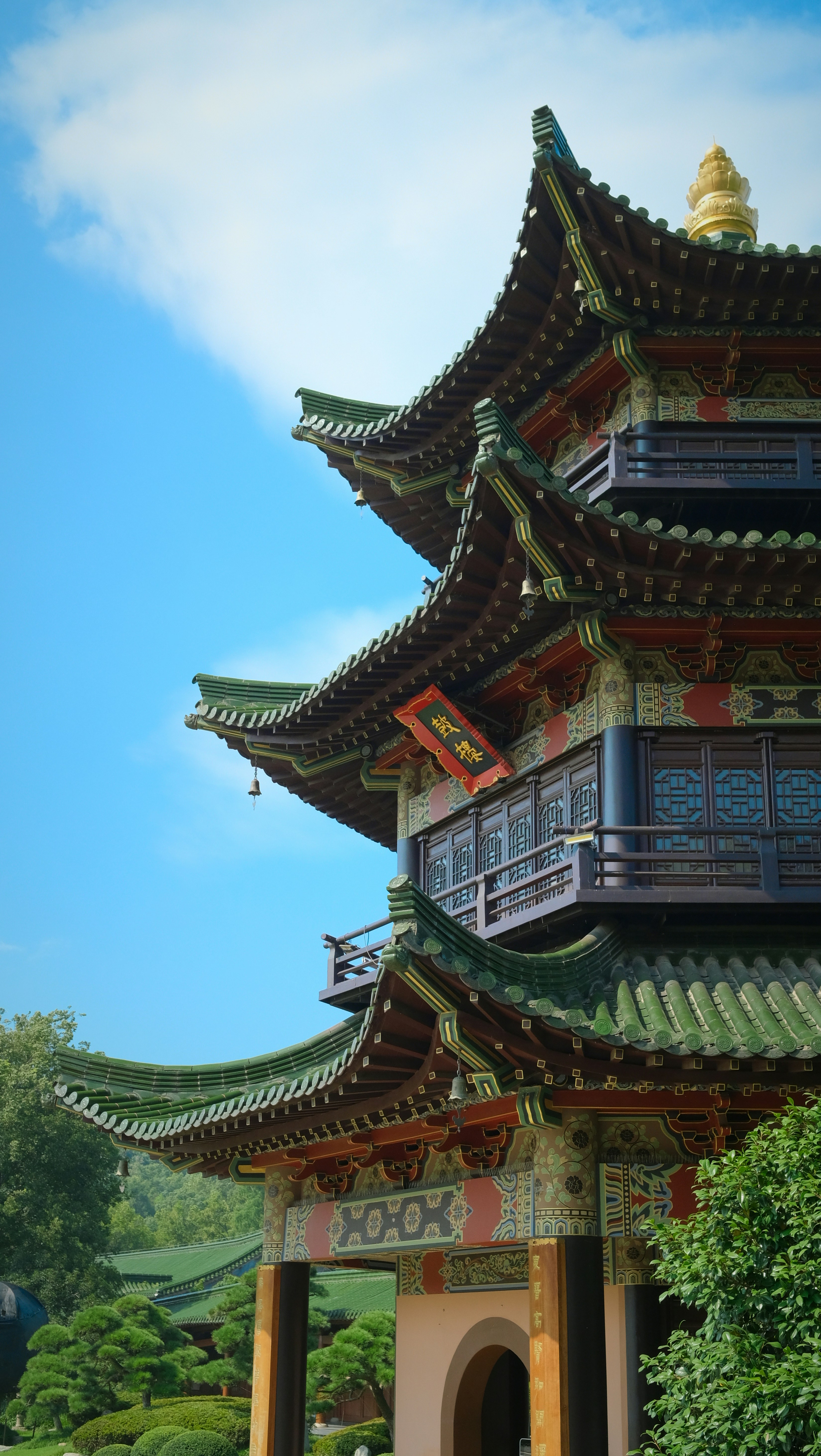 Tiered eaves and lacquered courage: a dragon-embellished pagoda rises against a bright sky