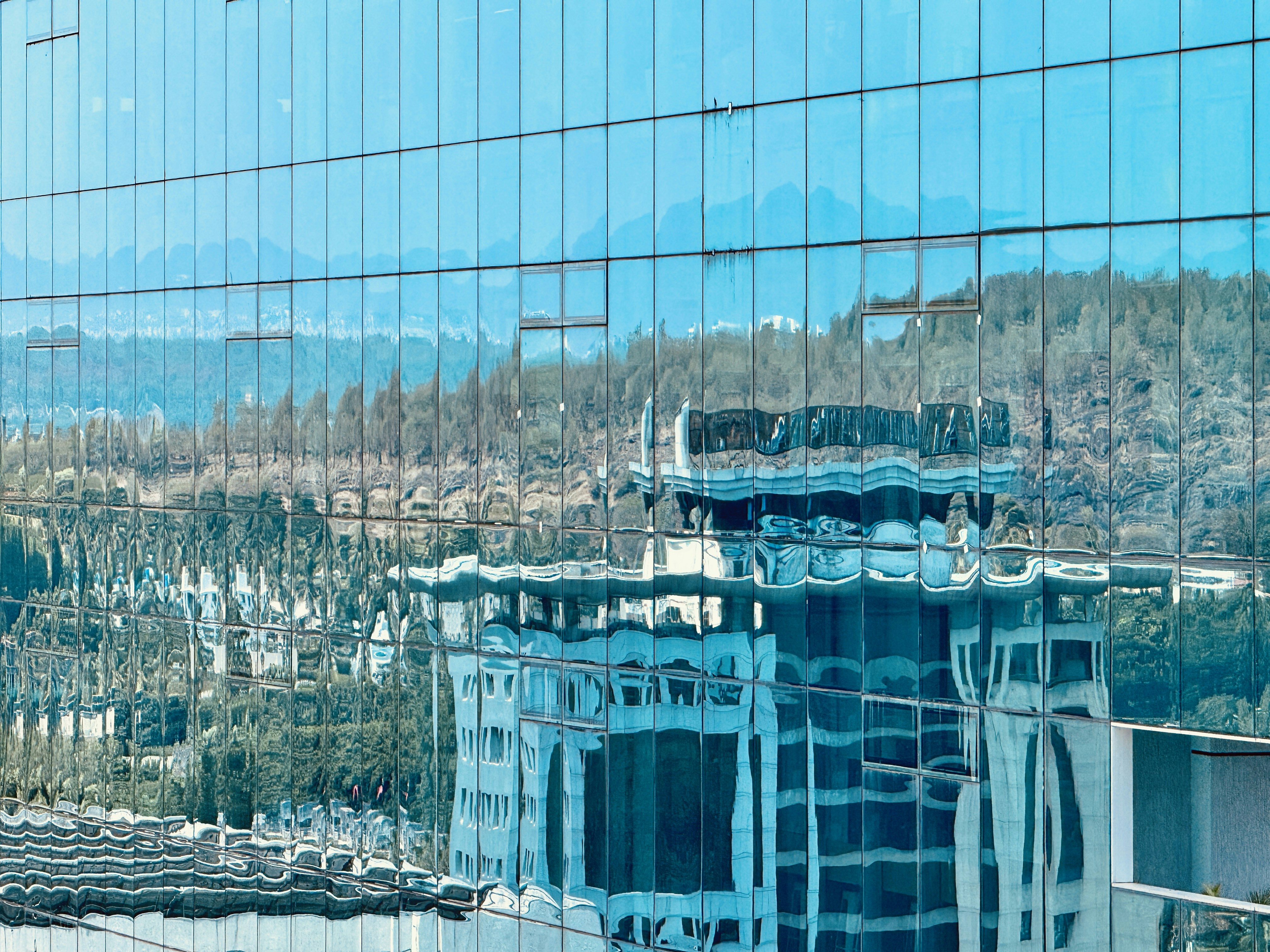 Faceted Glass: Reflections of a City Through a Wavy Facade