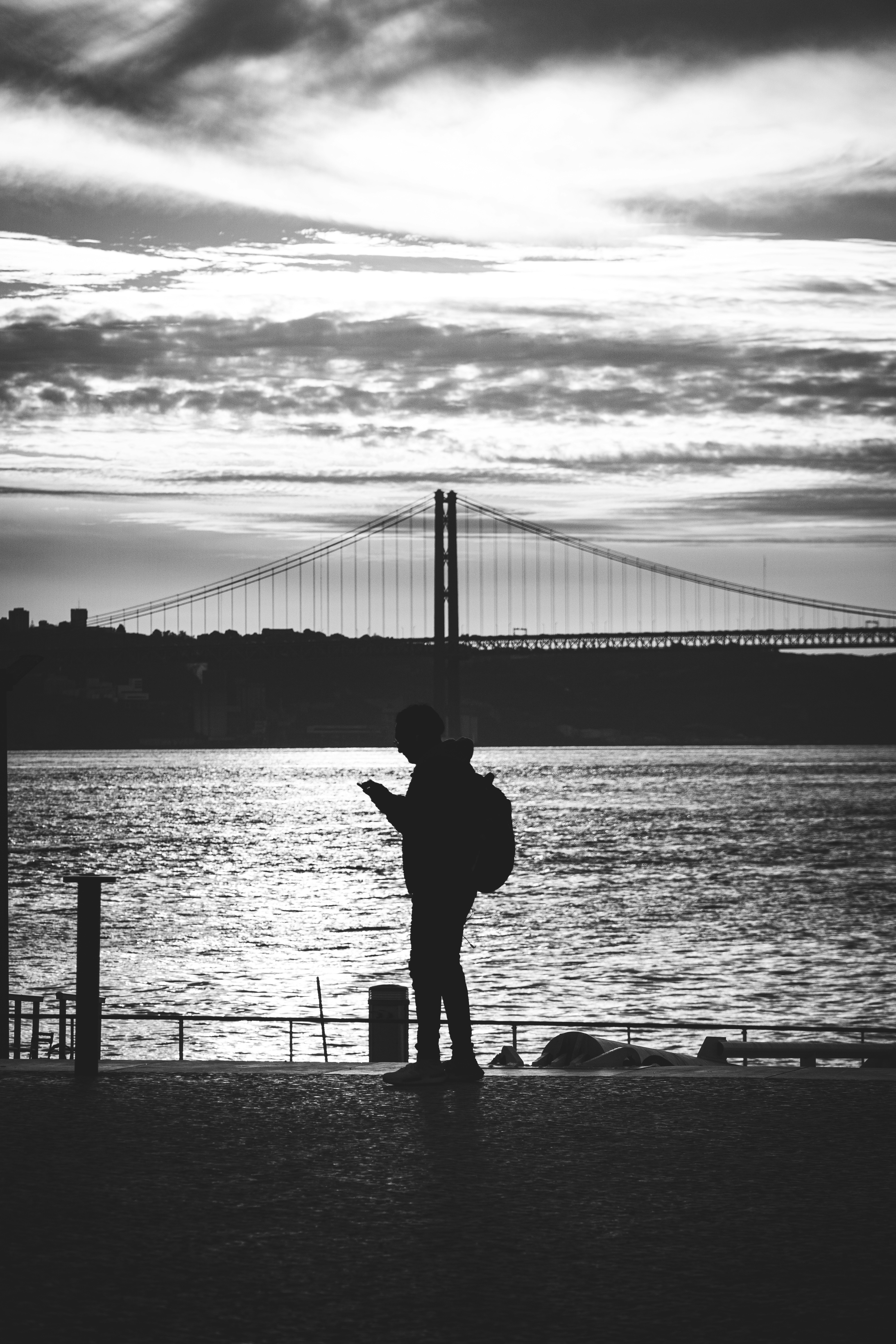 Silhouette by the Waterfront: A Reader Beneath the Bridge