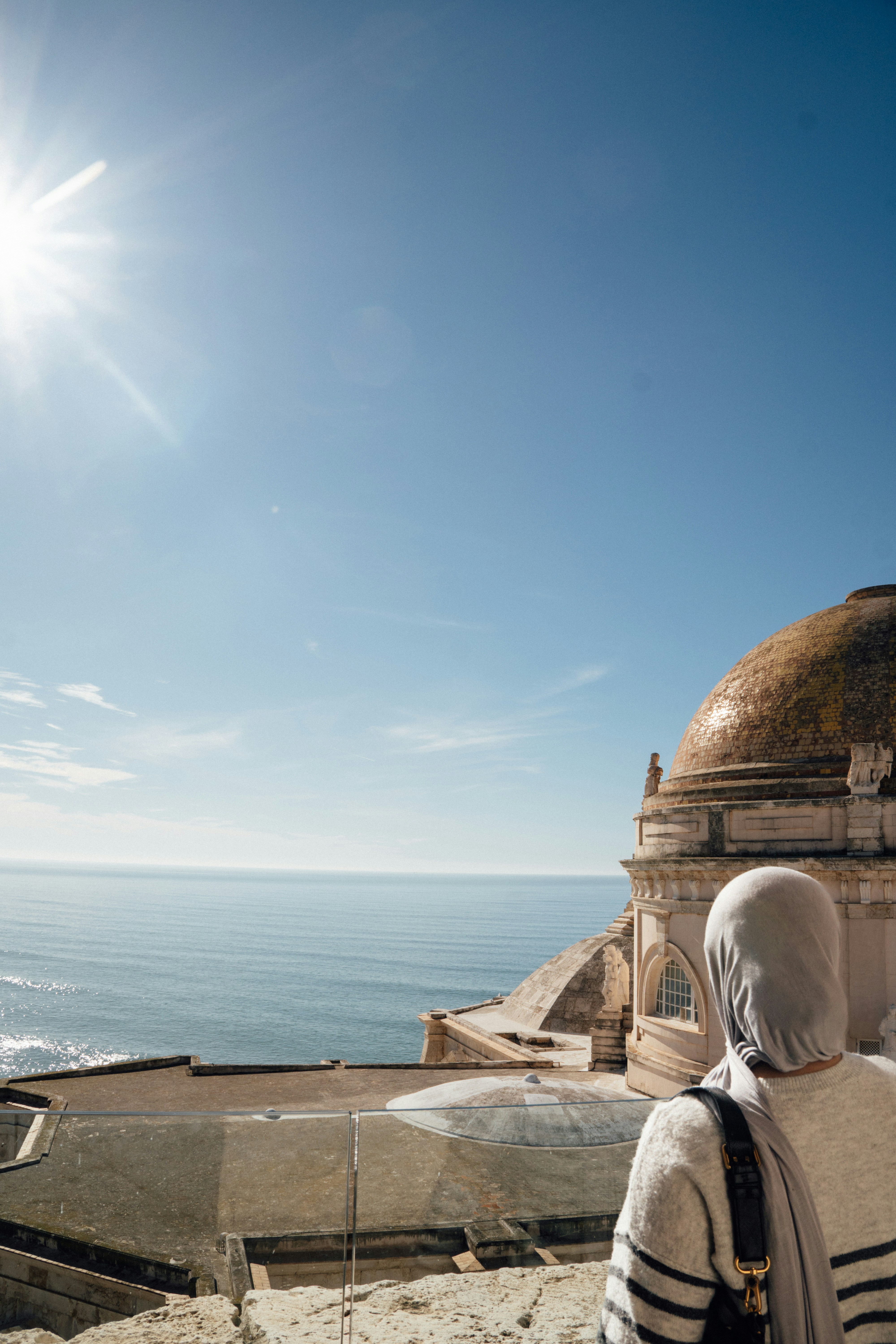 Sunlit Terrace Overlook with Veiled Visitor by a Golden Dome