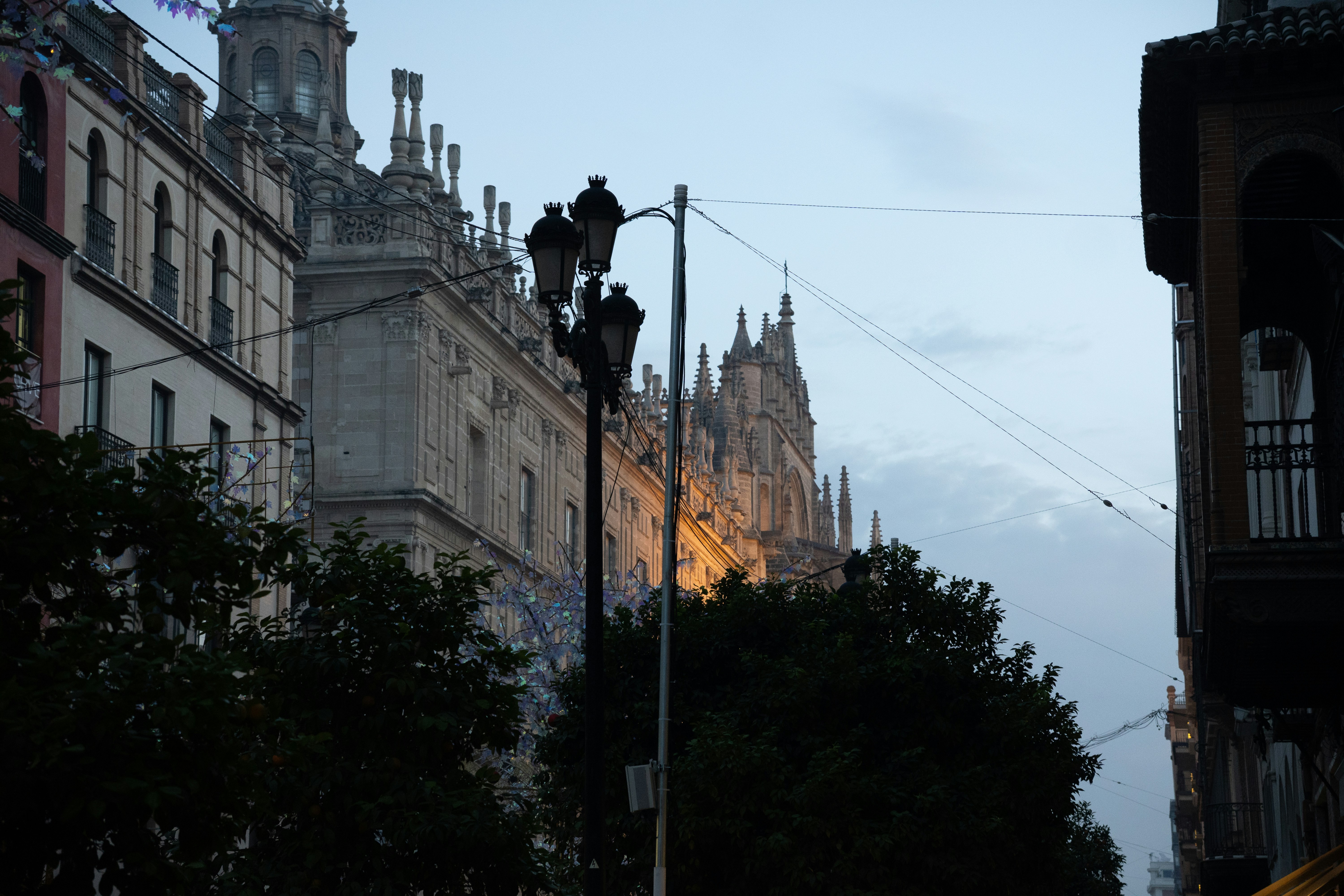 Gothic Towers Beyond the Street Lamps at Dusk