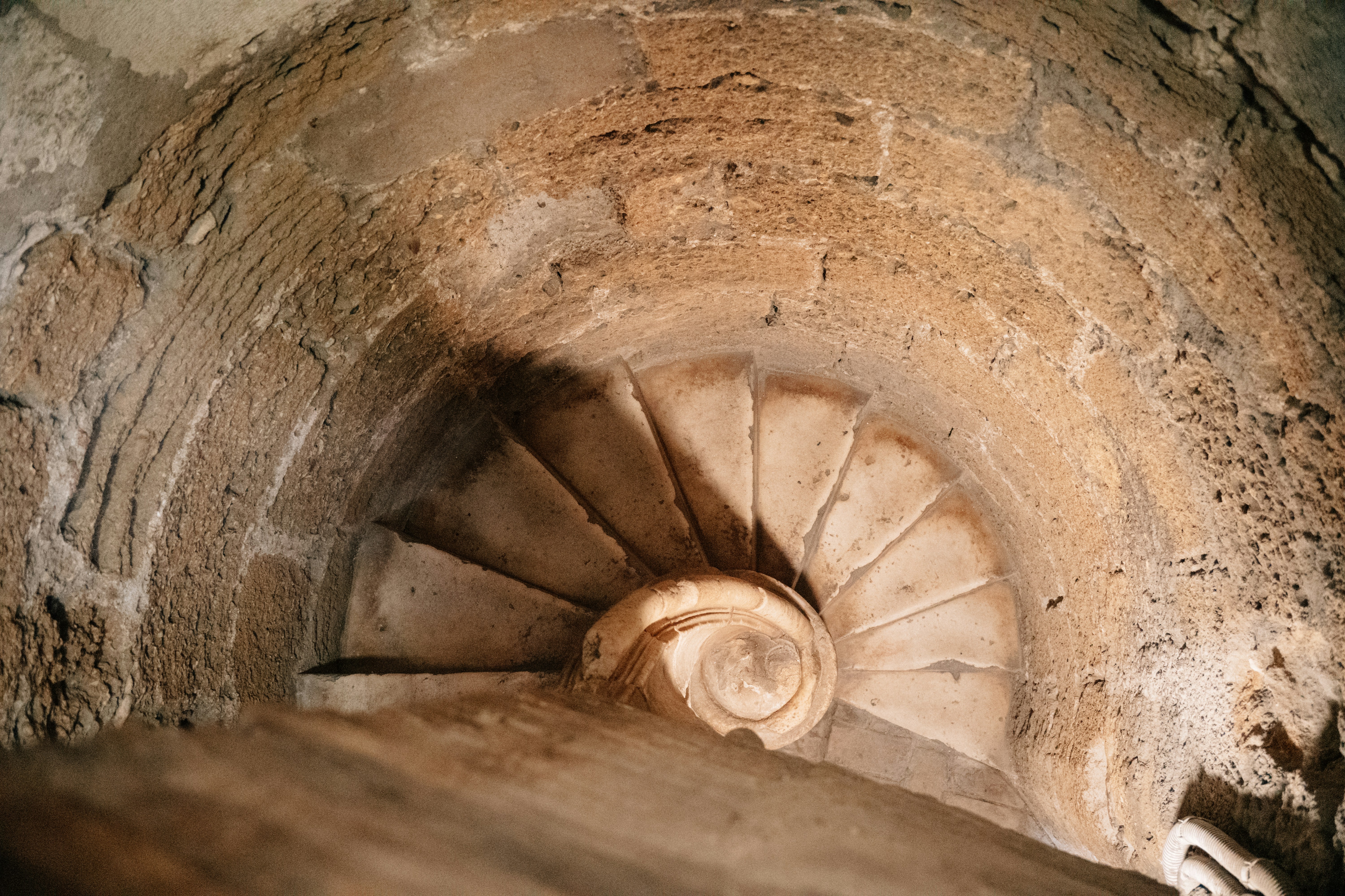 Spiral Descent: A Weathered Staircase Carved into Stone