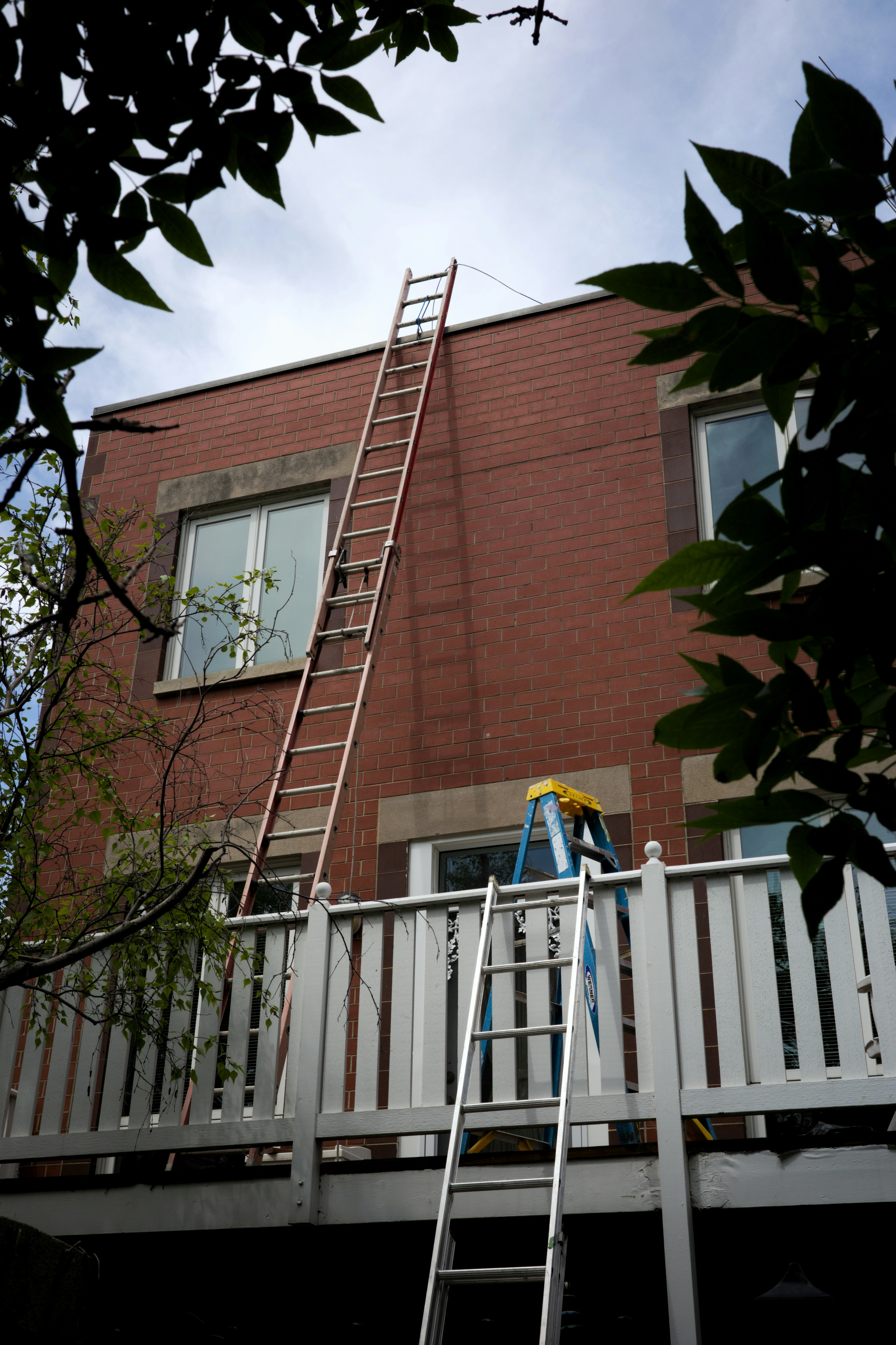 Ladder Between Levels: Climbing the Brick Facade