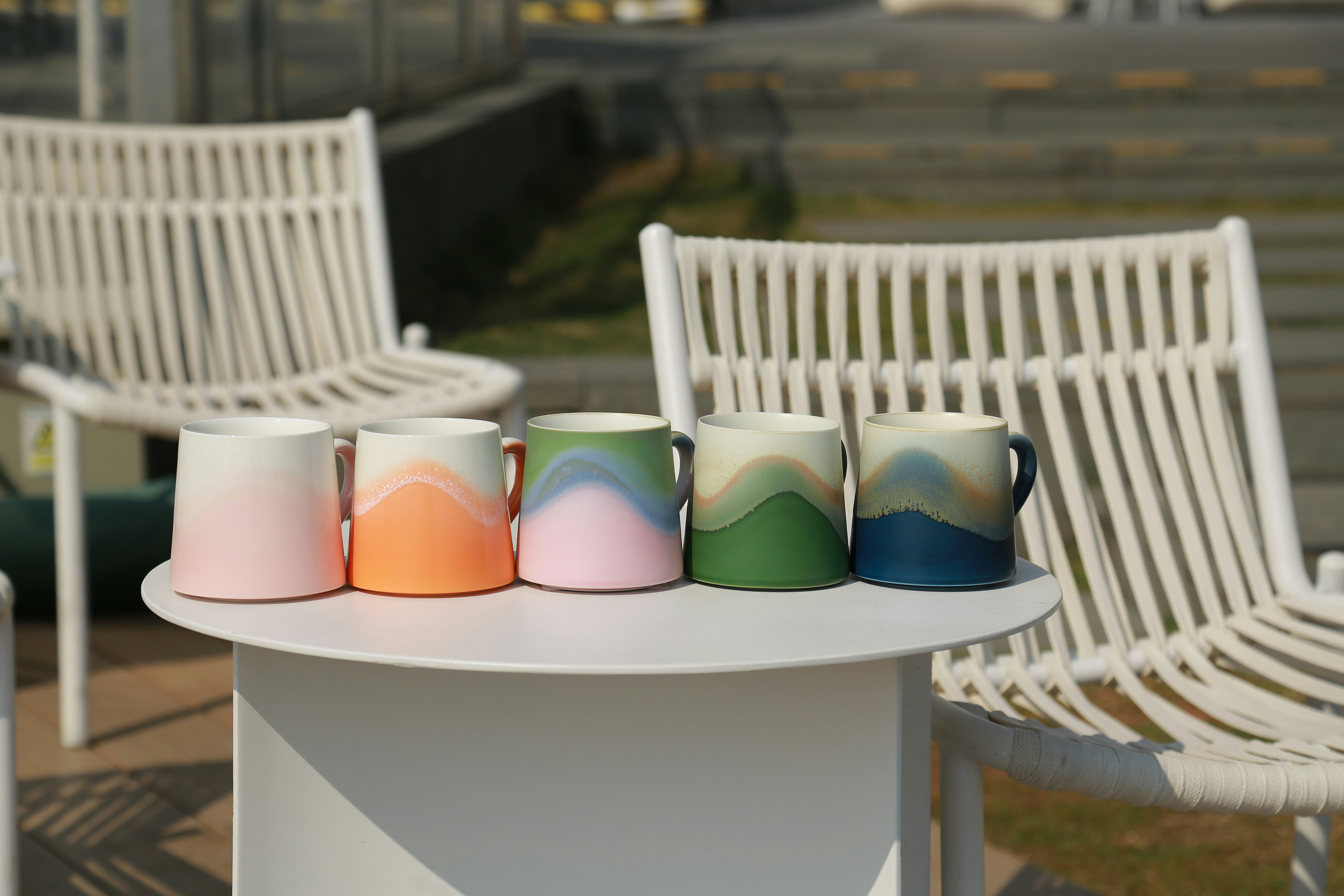 Colorful Mugs on a Quiet Outdoor Table