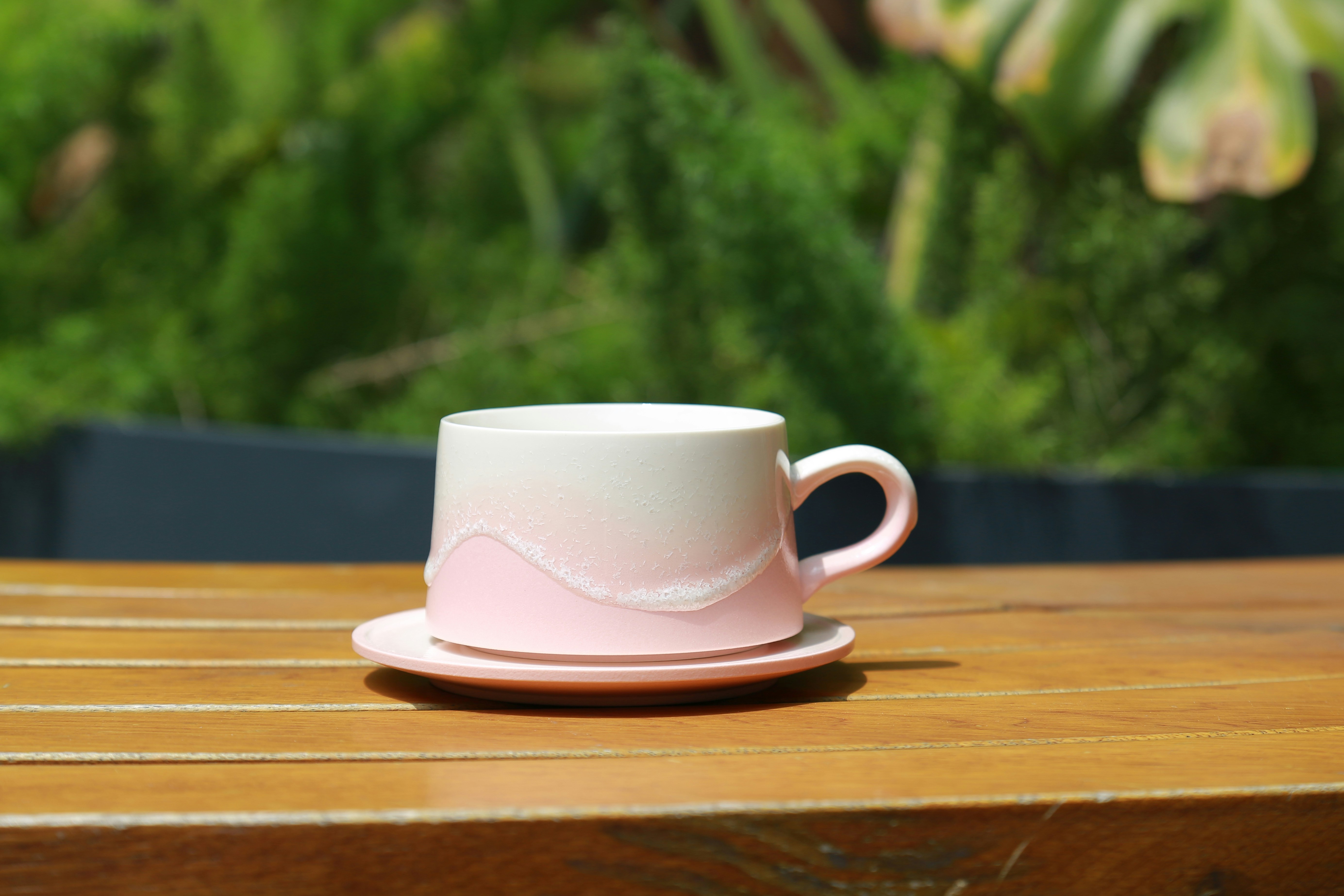 Pastel Teacup on a Sunlit Wood Table