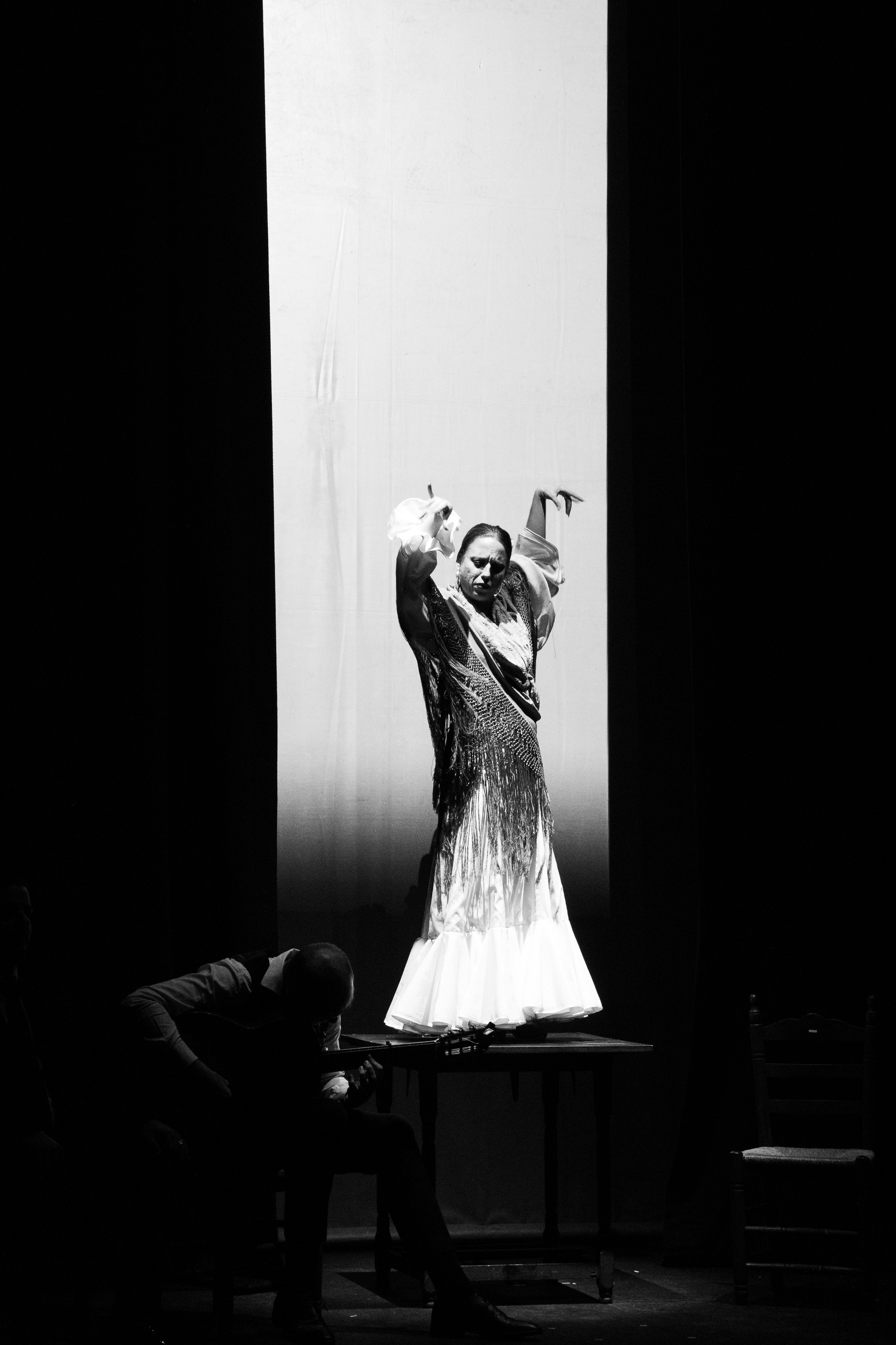 Silhouette of a Dancer Emerging from a Narrow Spotlight