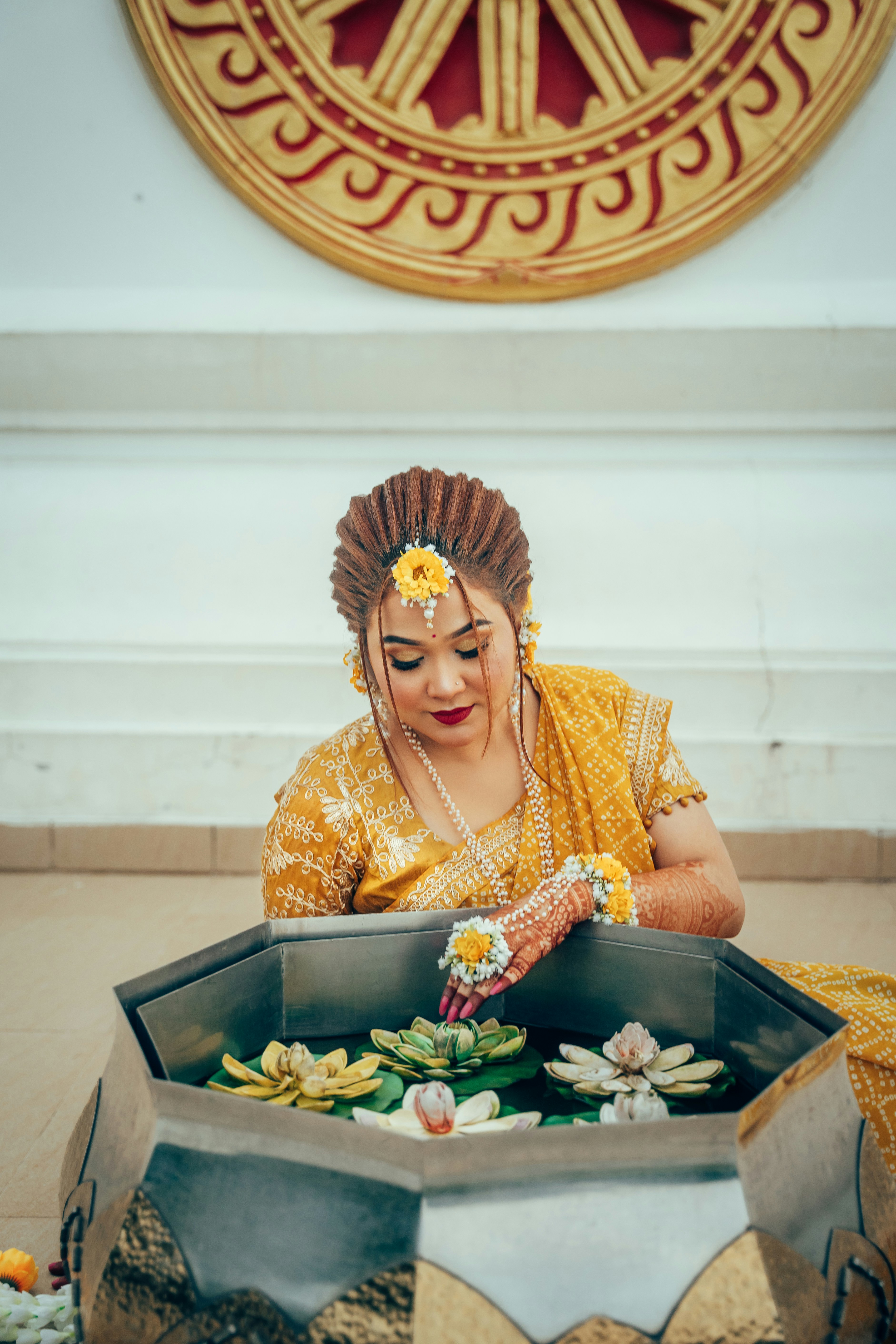 Golden Rituals: A Woman in Yellow Adorns a Sacred Water Lotus