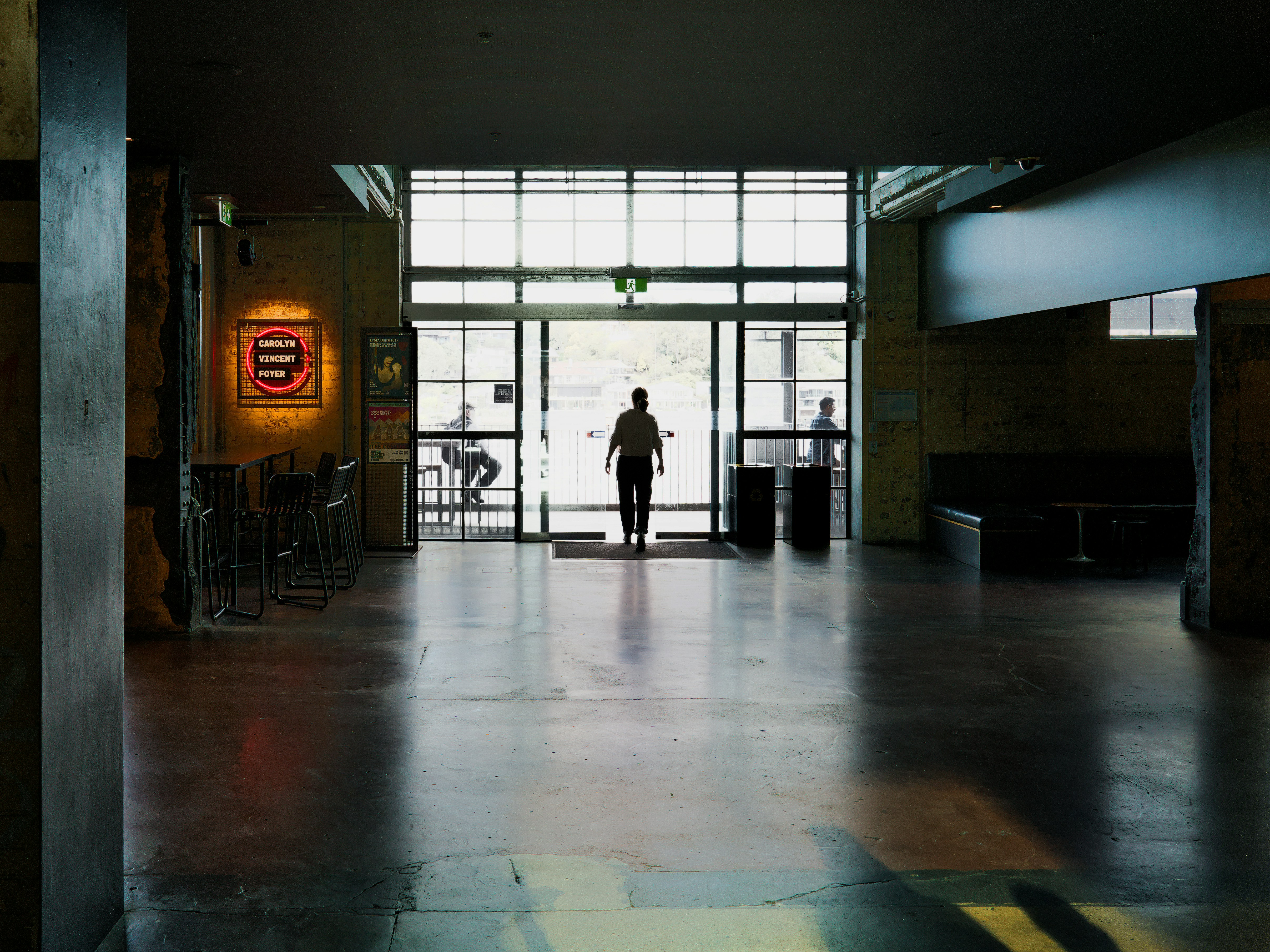 Silhouette at the Entrance: A Quiet Moment in an Industrial Lobby