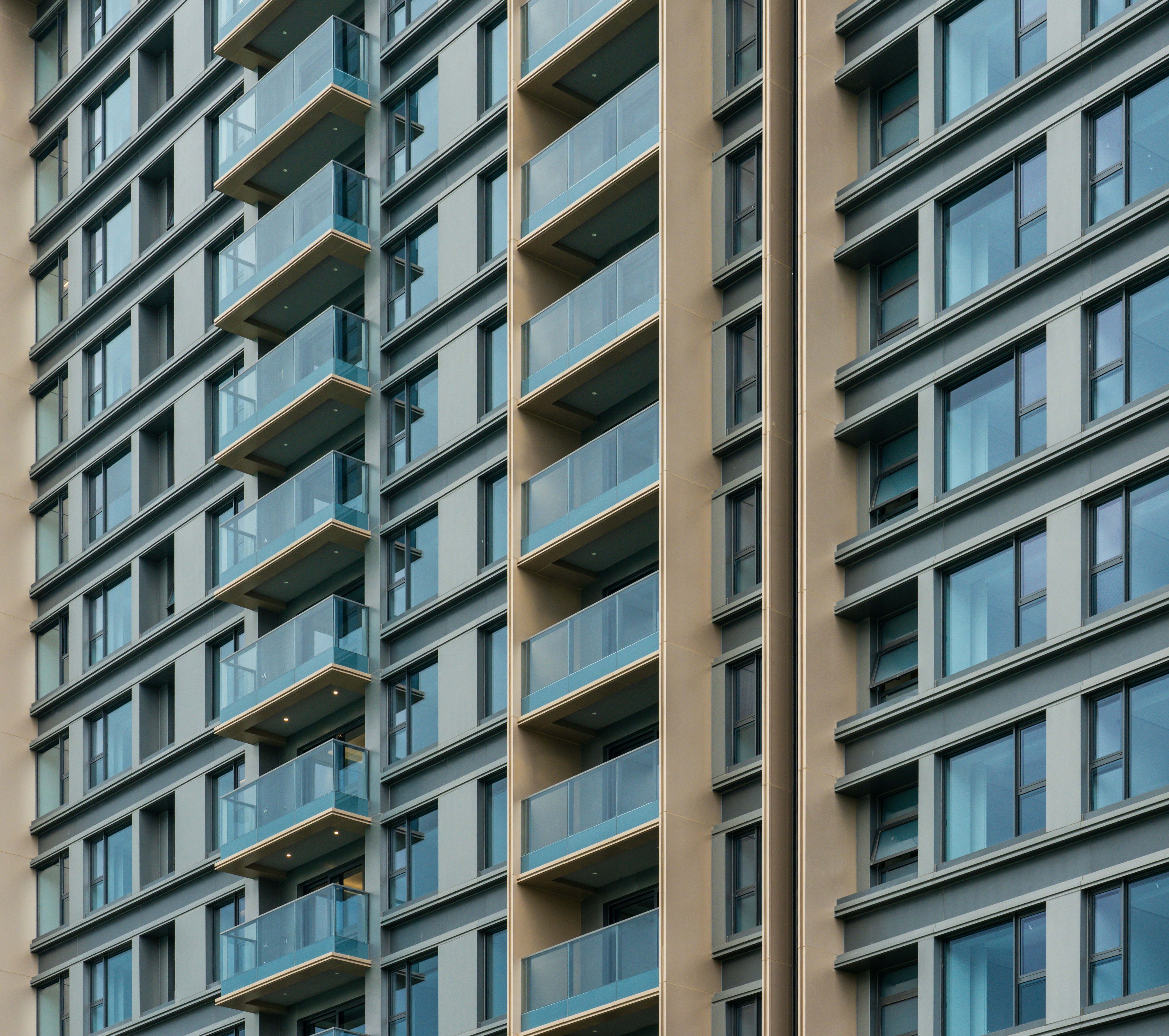 Modern apartment building exterior with many windows and balconies.