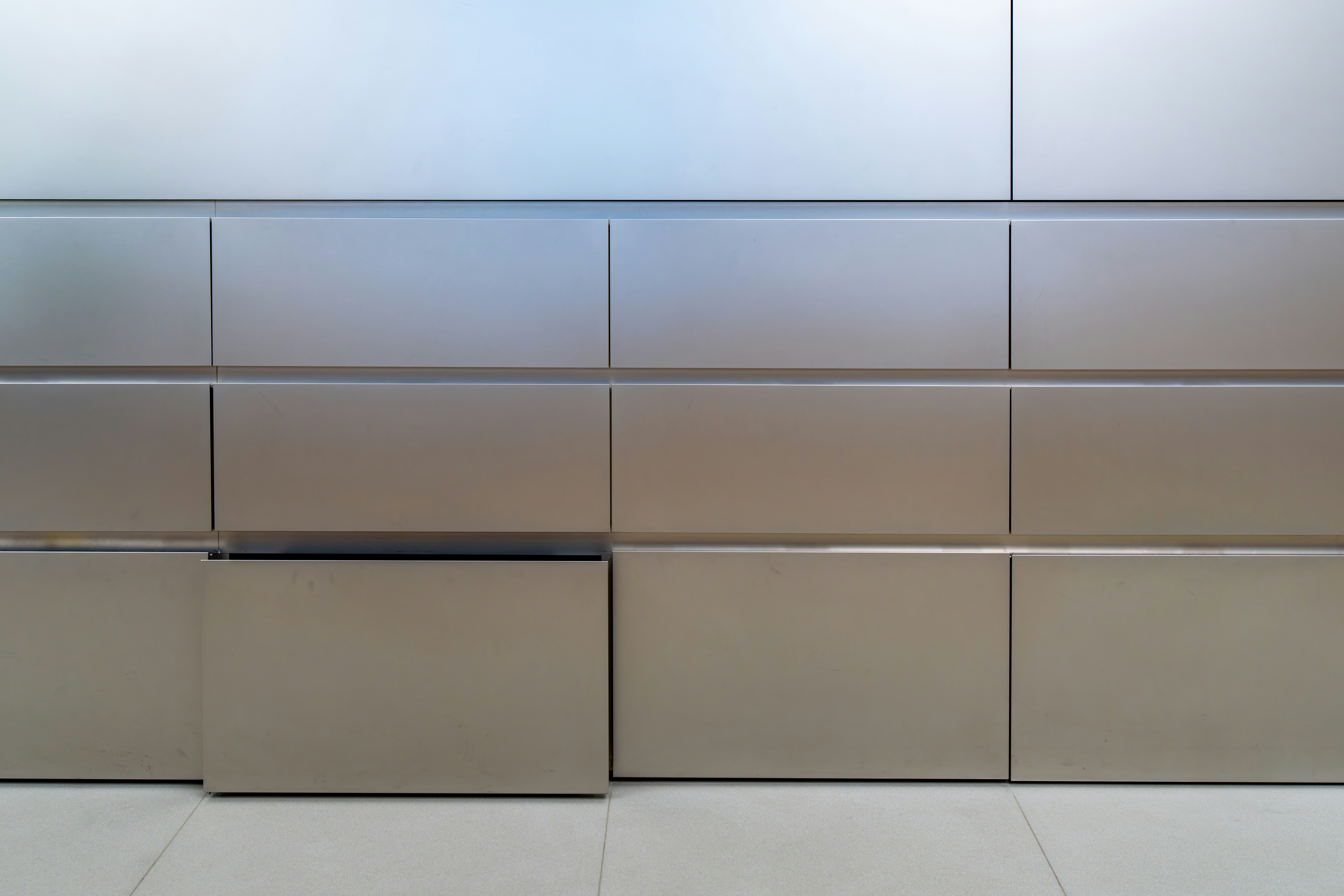 Metallic rectangular panels forming a modern wall.