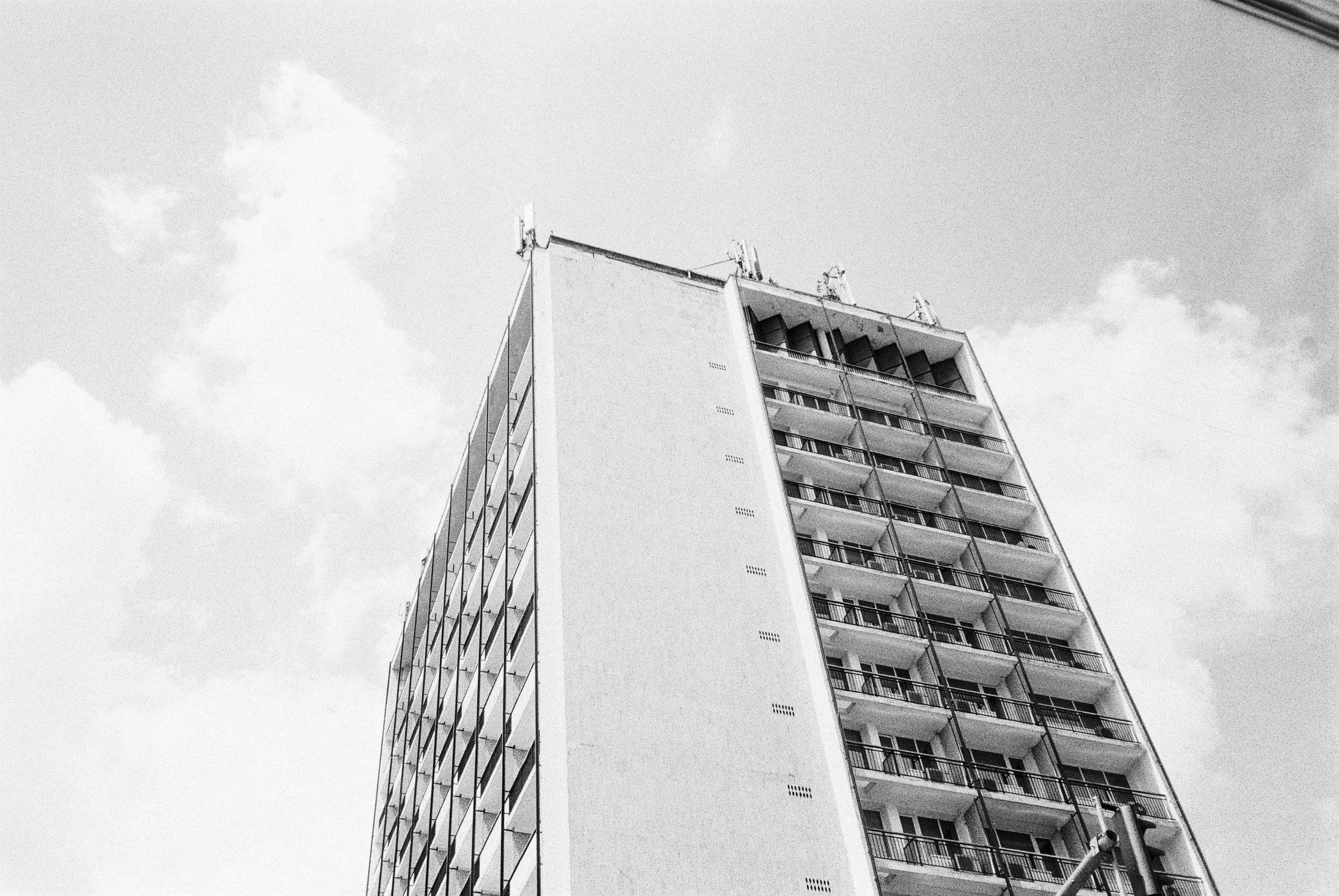 Facing Skyward: A Modern Tower Reaching for the Clouded Horizon