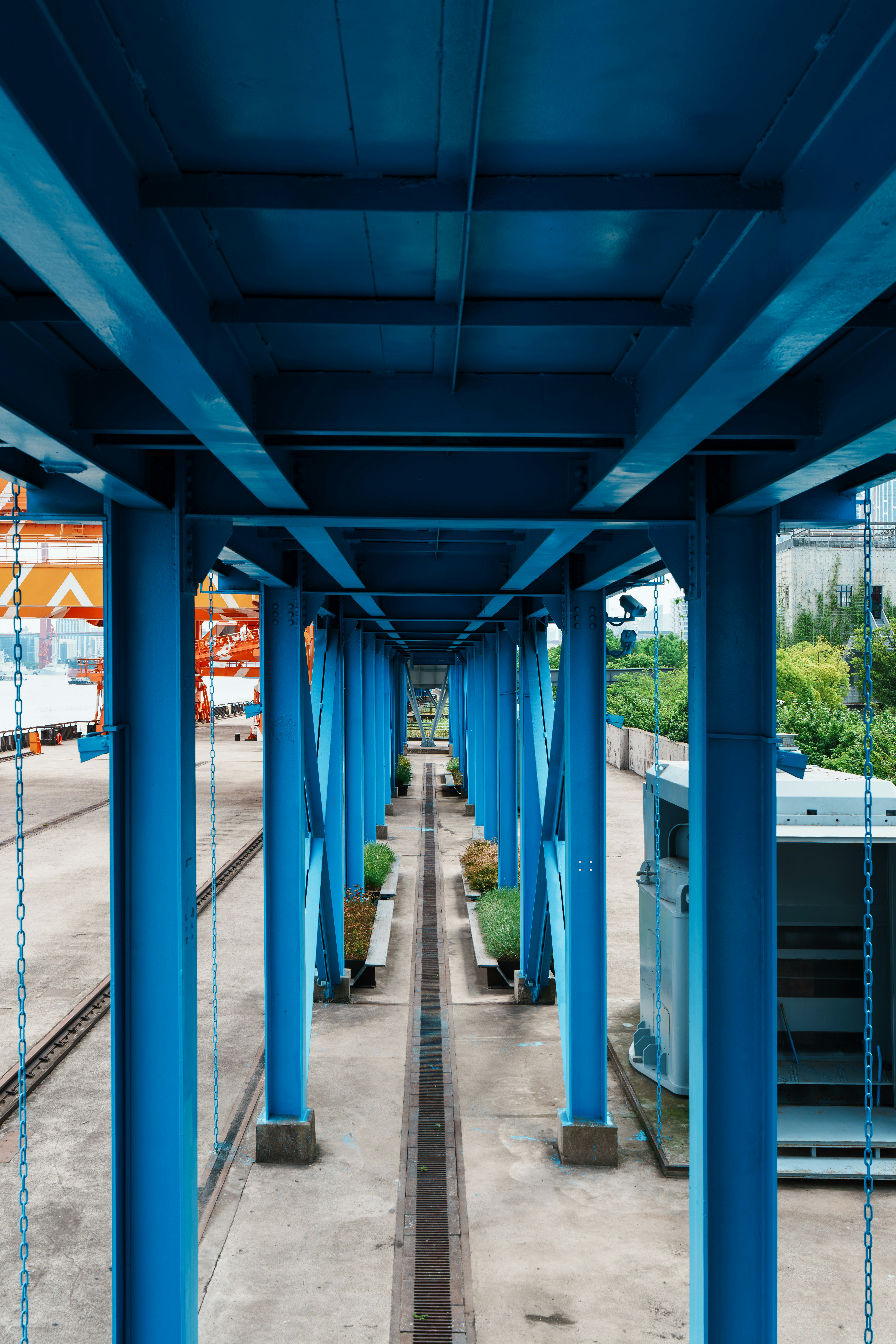 Blue Corridor: Industrial Trusswork Vanishing Point