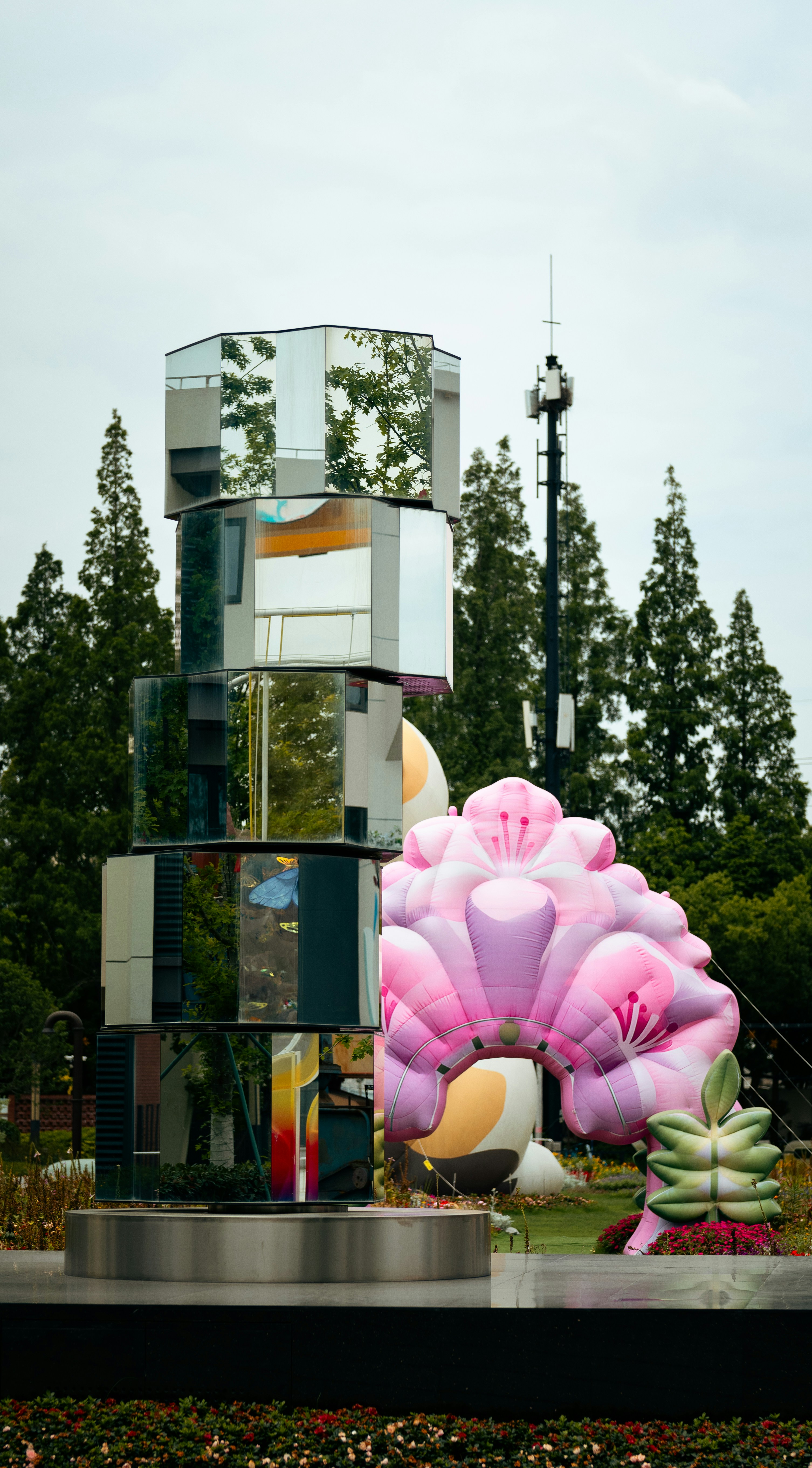 Mirrored Stack and Pink Shell sculpture: urban sculpture garden centerpiece