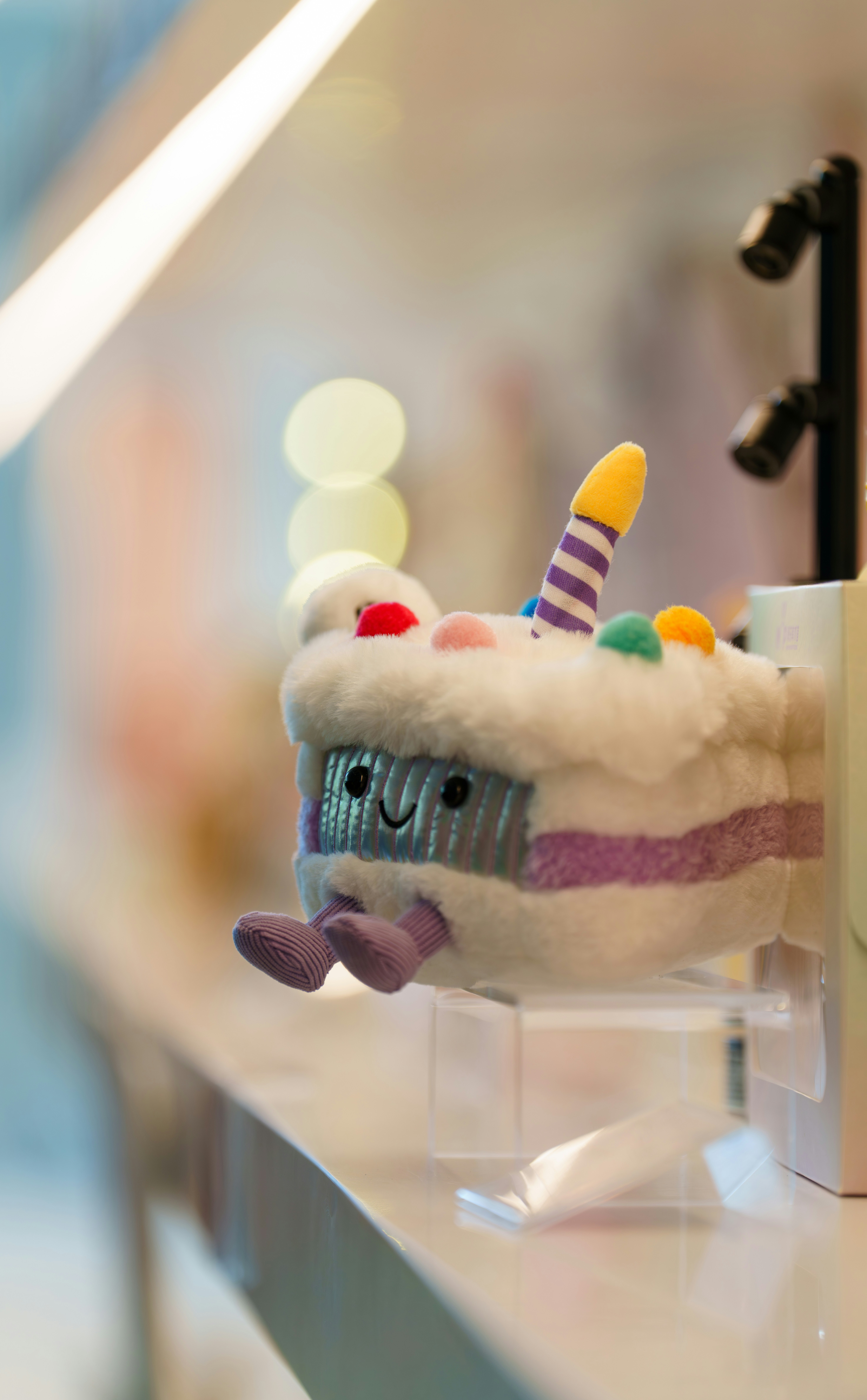 A cute plush birthday cake slice with a candle.