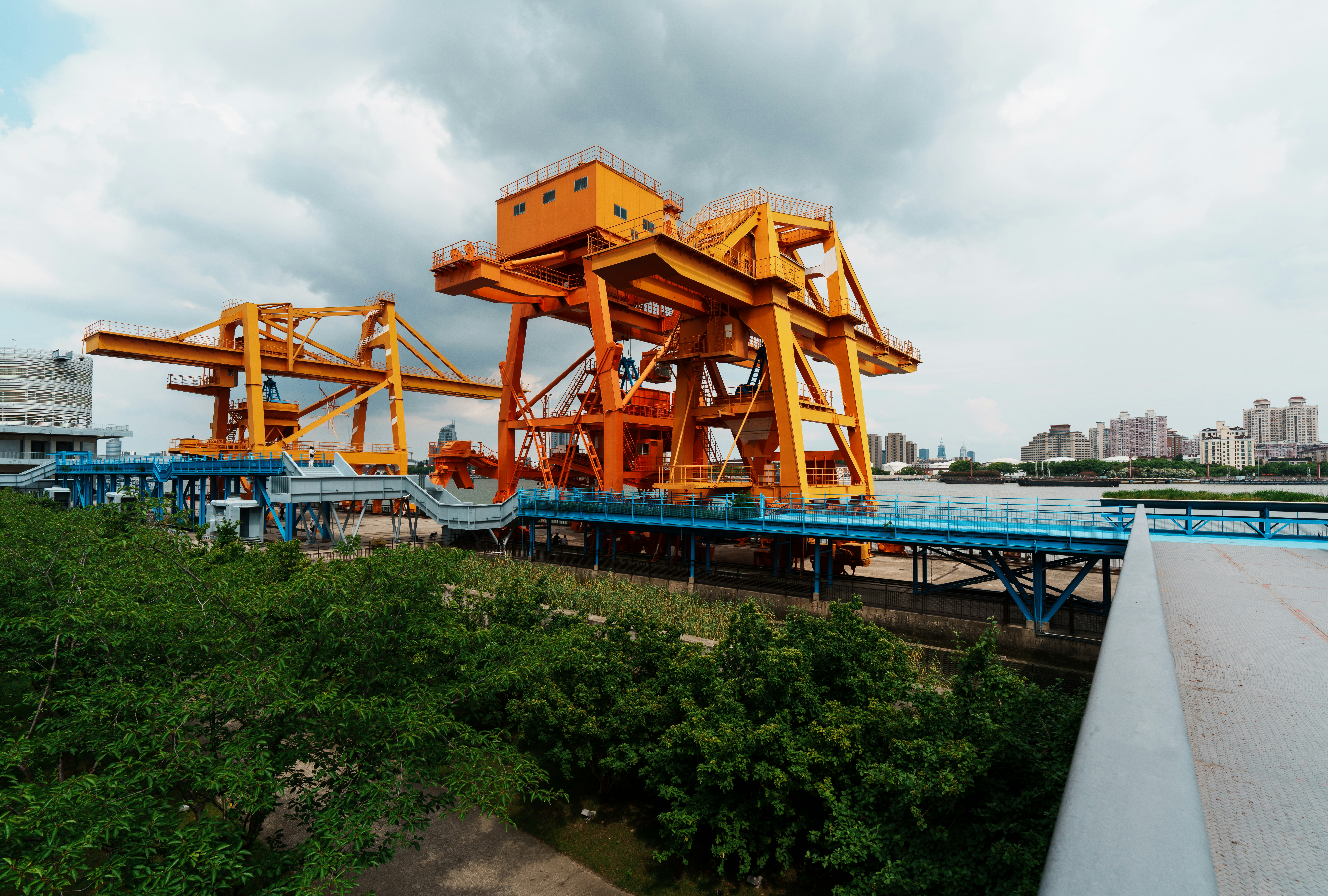 Crimson Machinery: Orange Gantry Over the Riverfront