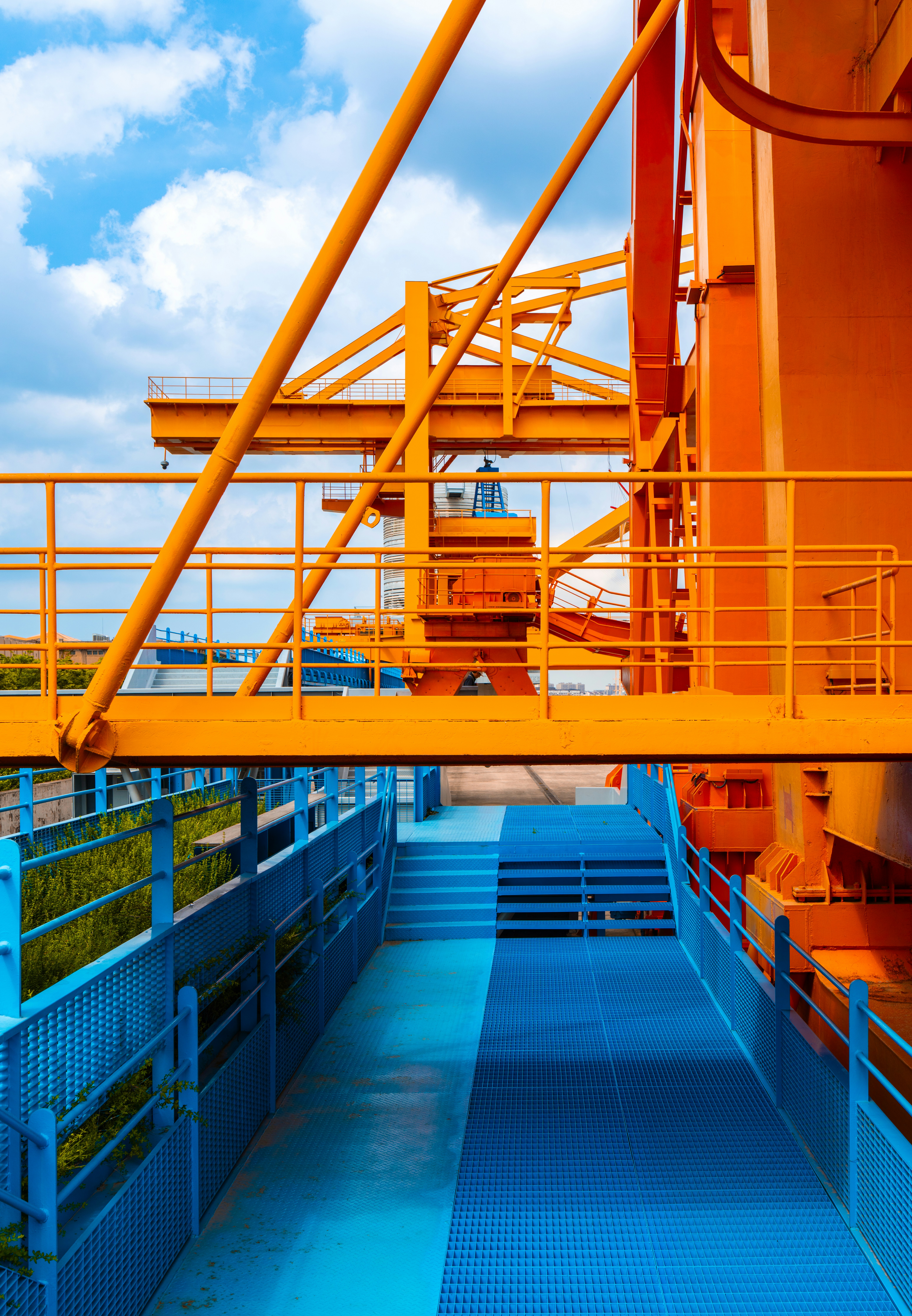 Bright orange industrial structures with blue walkways.