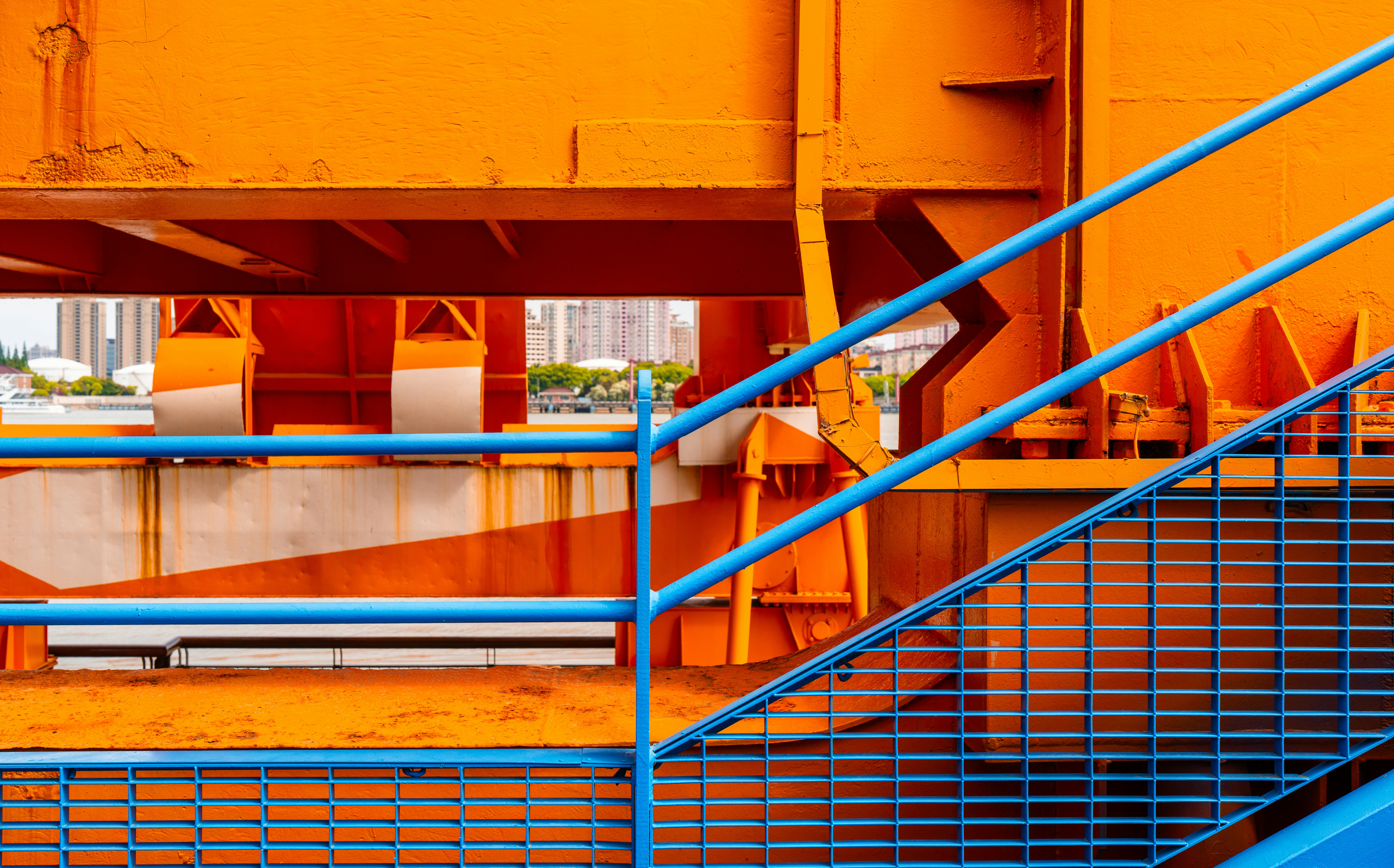 Industrial Geometry: Orange Structure Meets Blue Rails