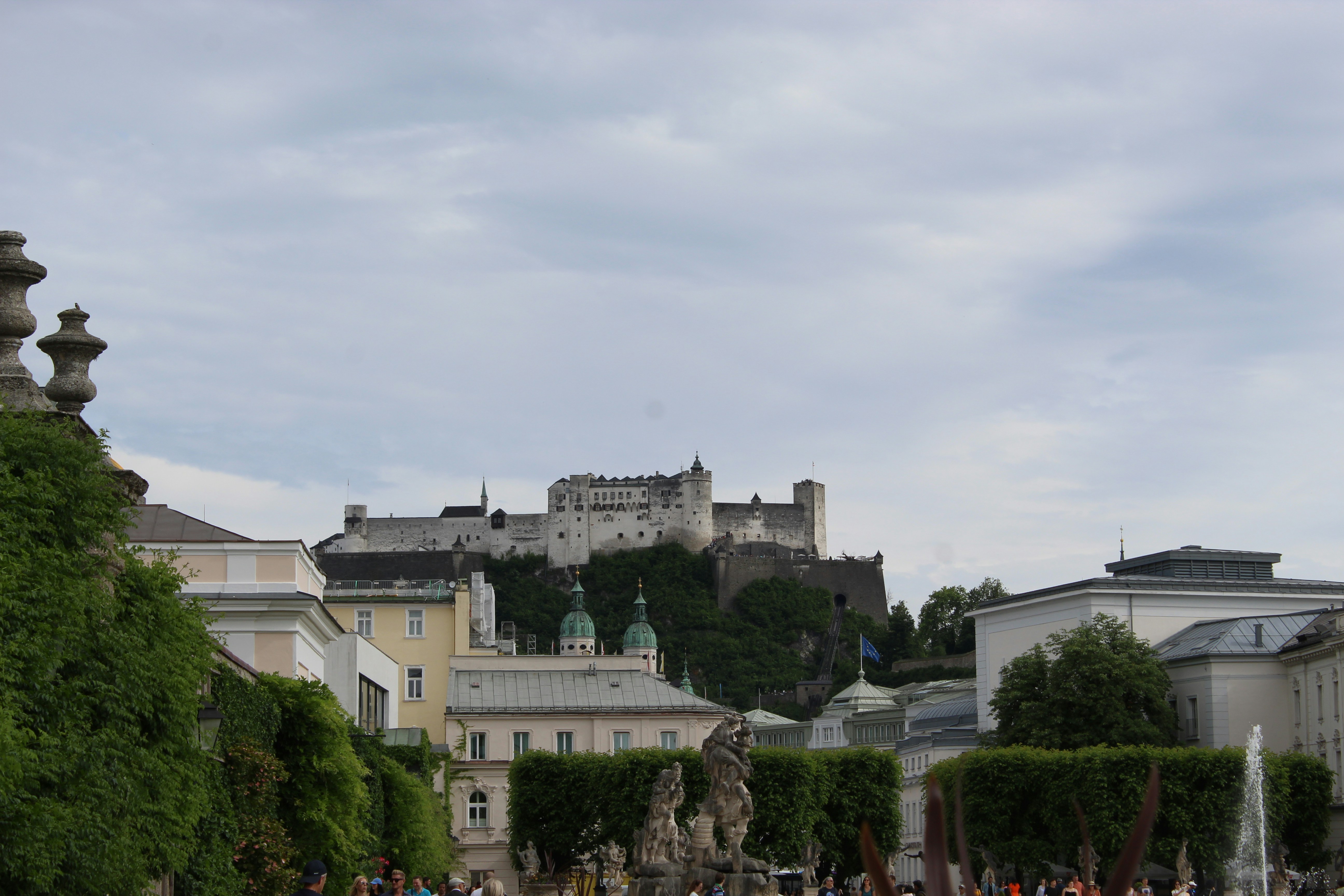 Castle over the city: a sunlit square with a distant fortress