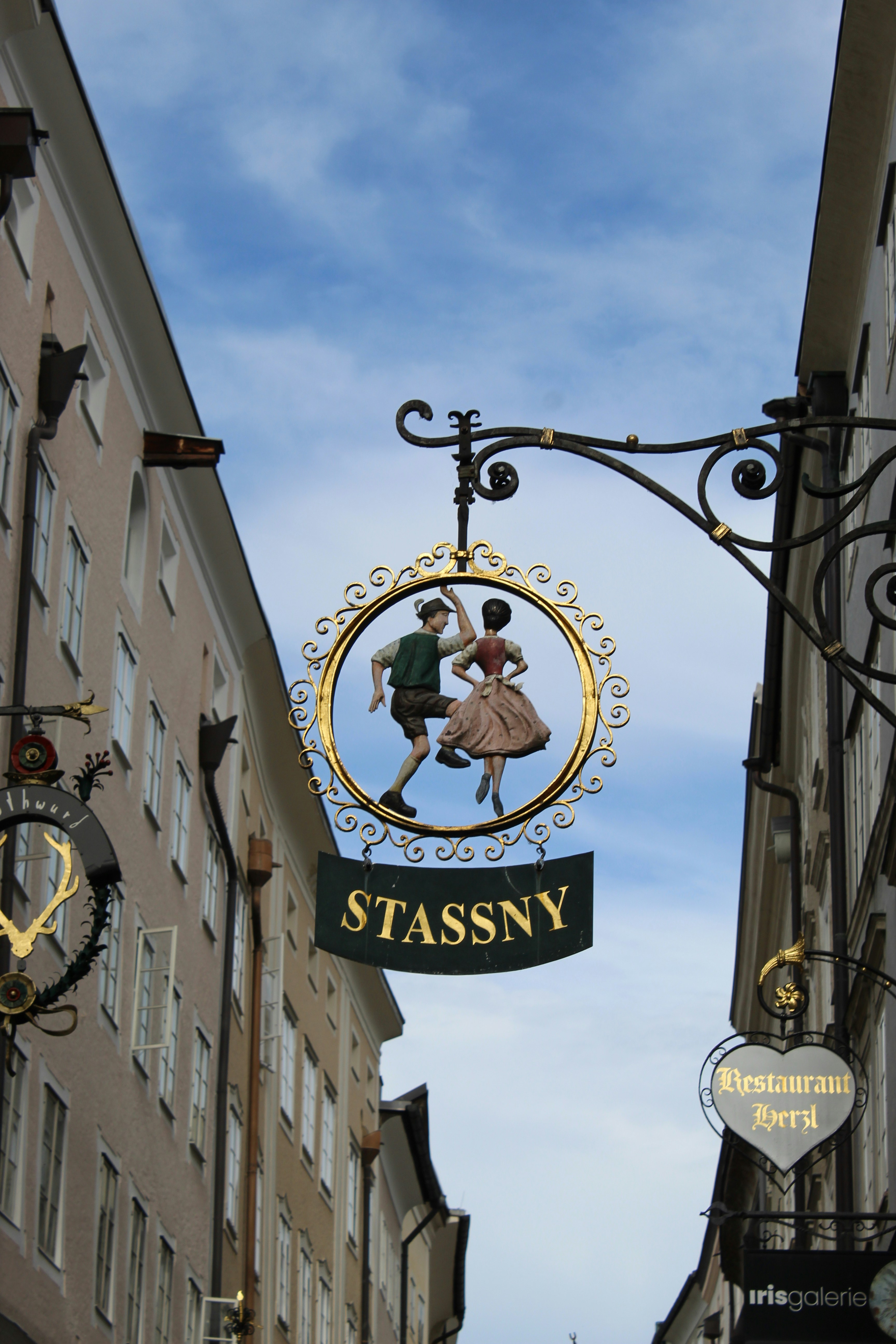 Ornate Signboard of a Dancing Couple in a European Arcade