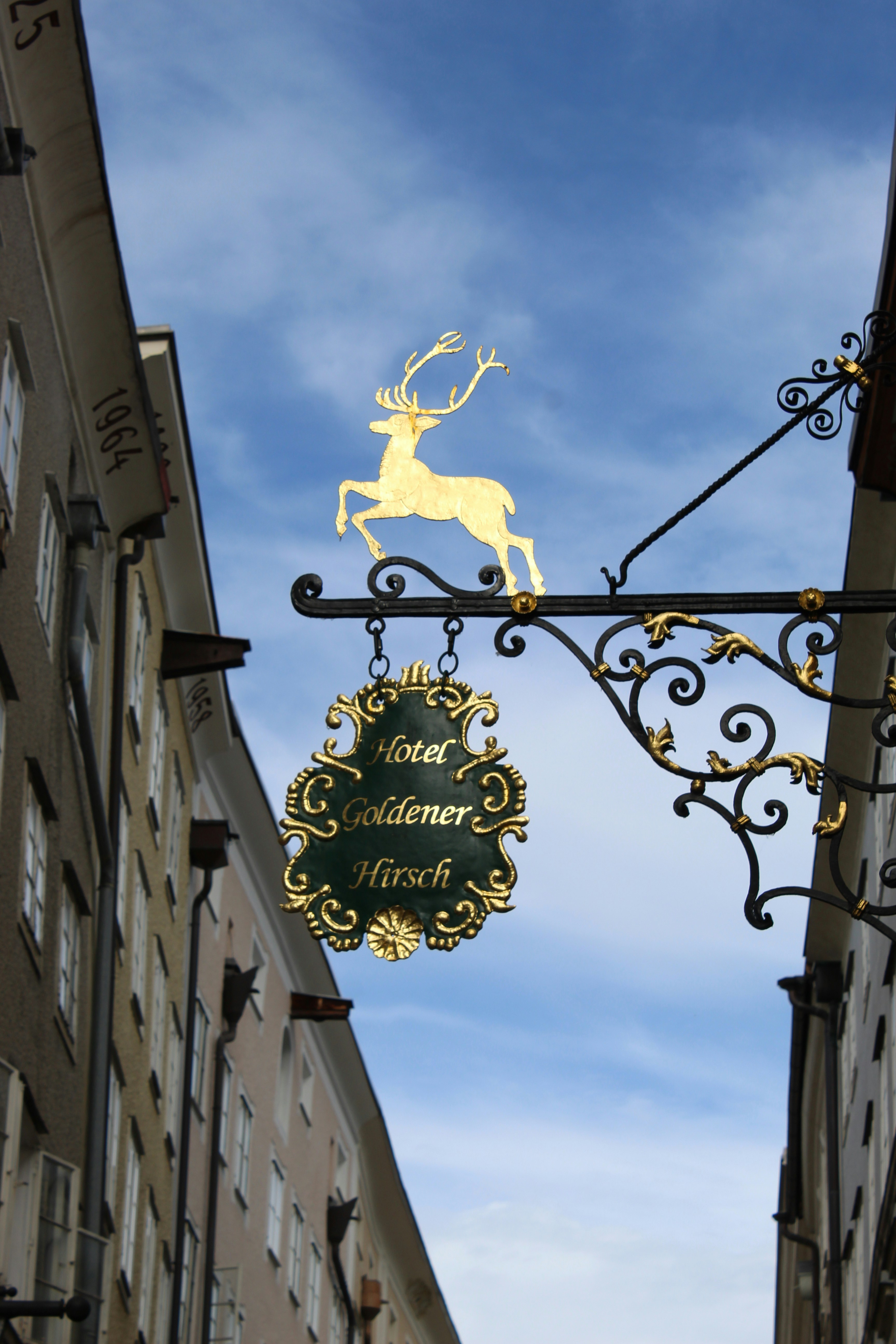 Golden Stag Sign Above Ornate Hotel Façade