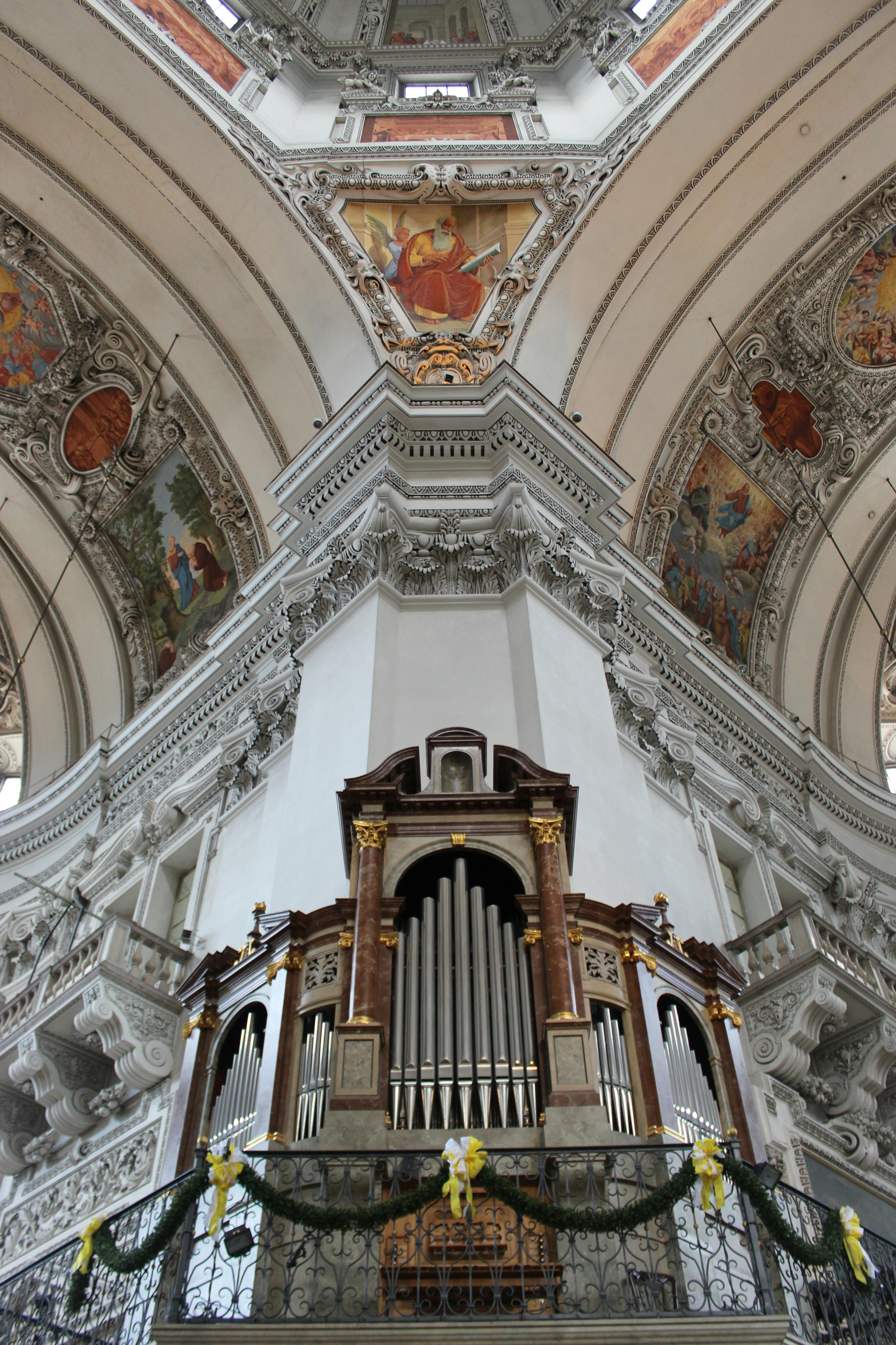 Ornate Choir Loft: A Pipe Organ Under Vaulted Frescoes