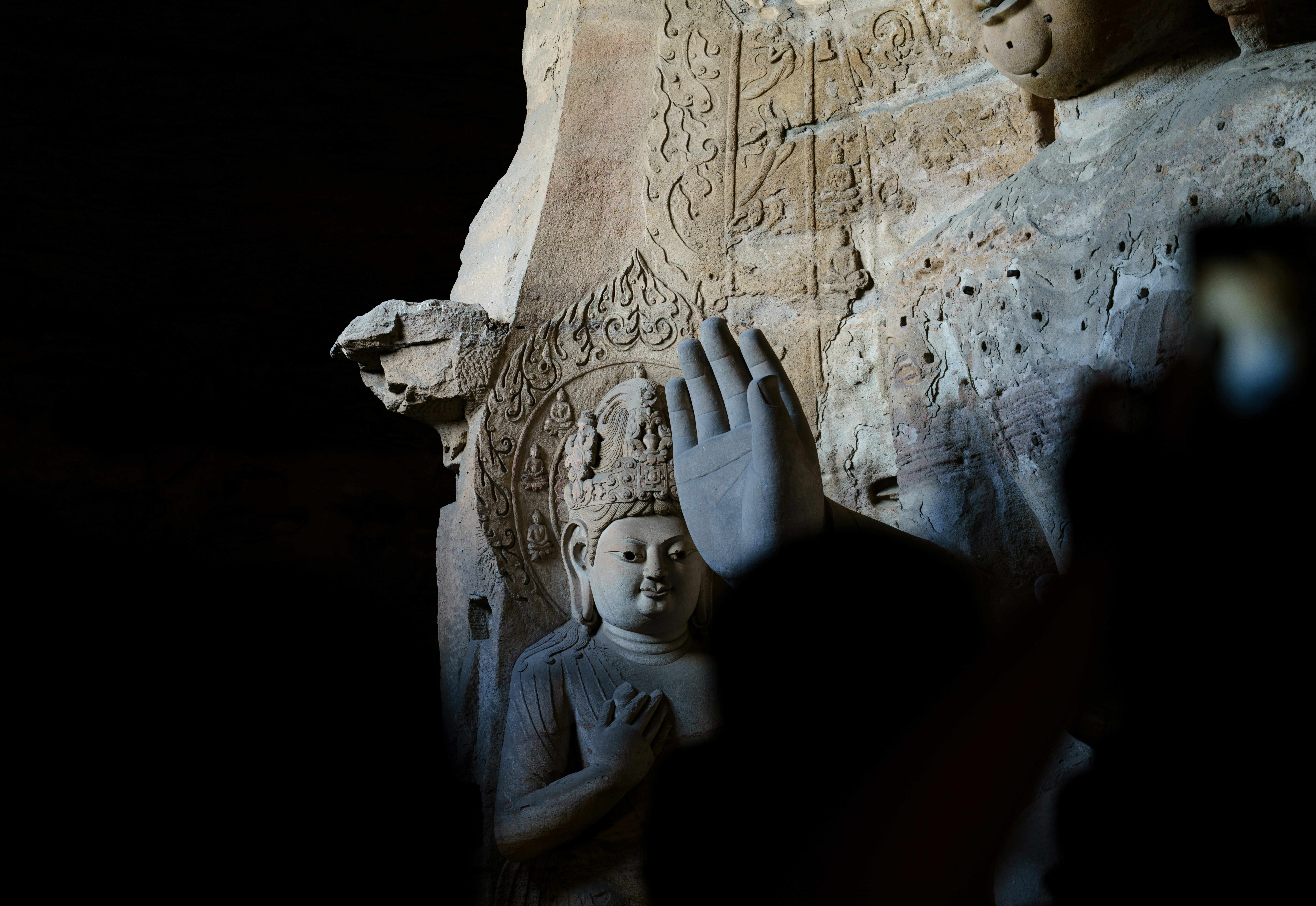 Whispered Stone: A Quiet Hand Over the Buddha’s Shoulder