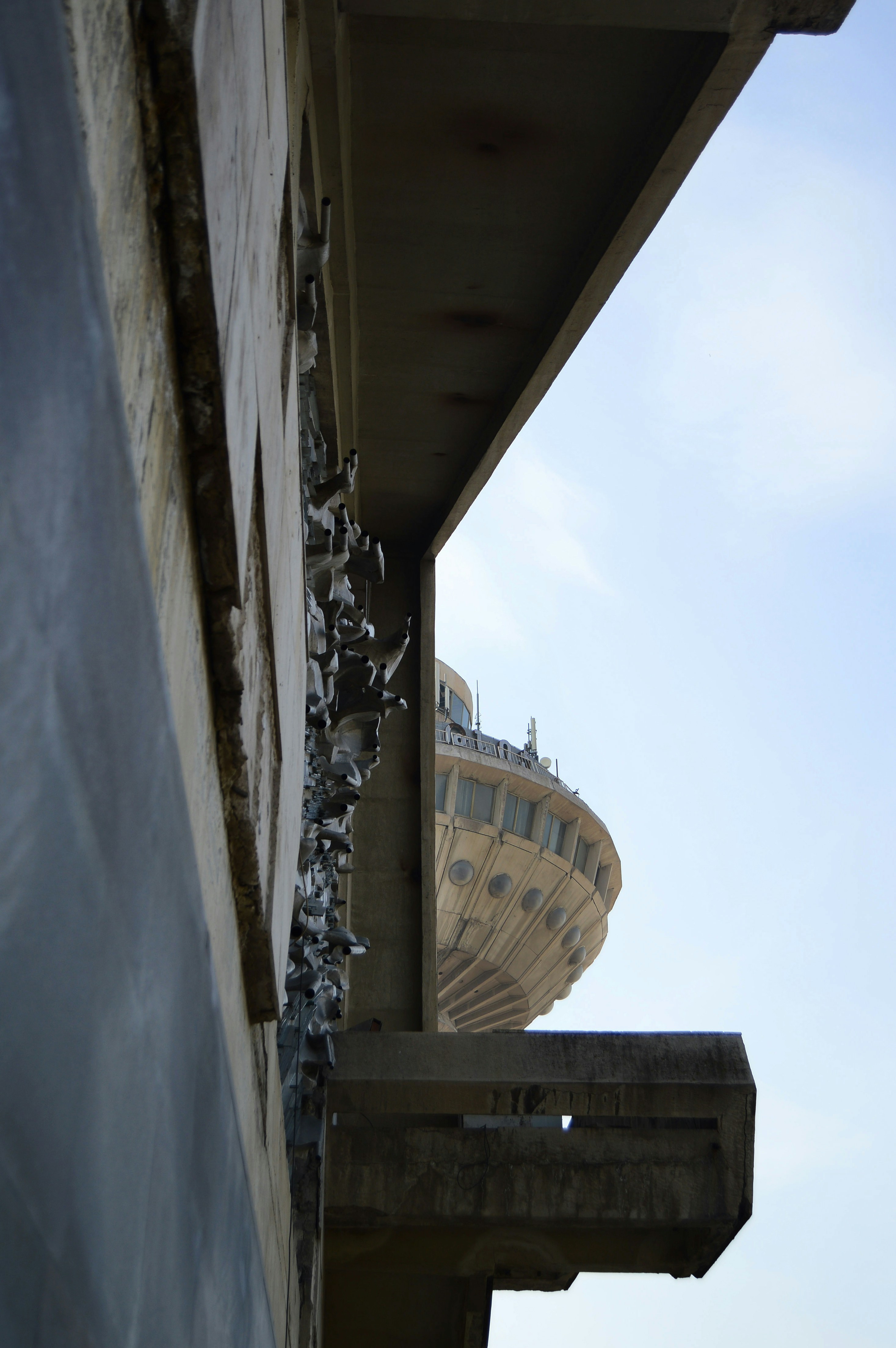 Upward Gaze: A Tower Peeking From Under a Concrete Span
