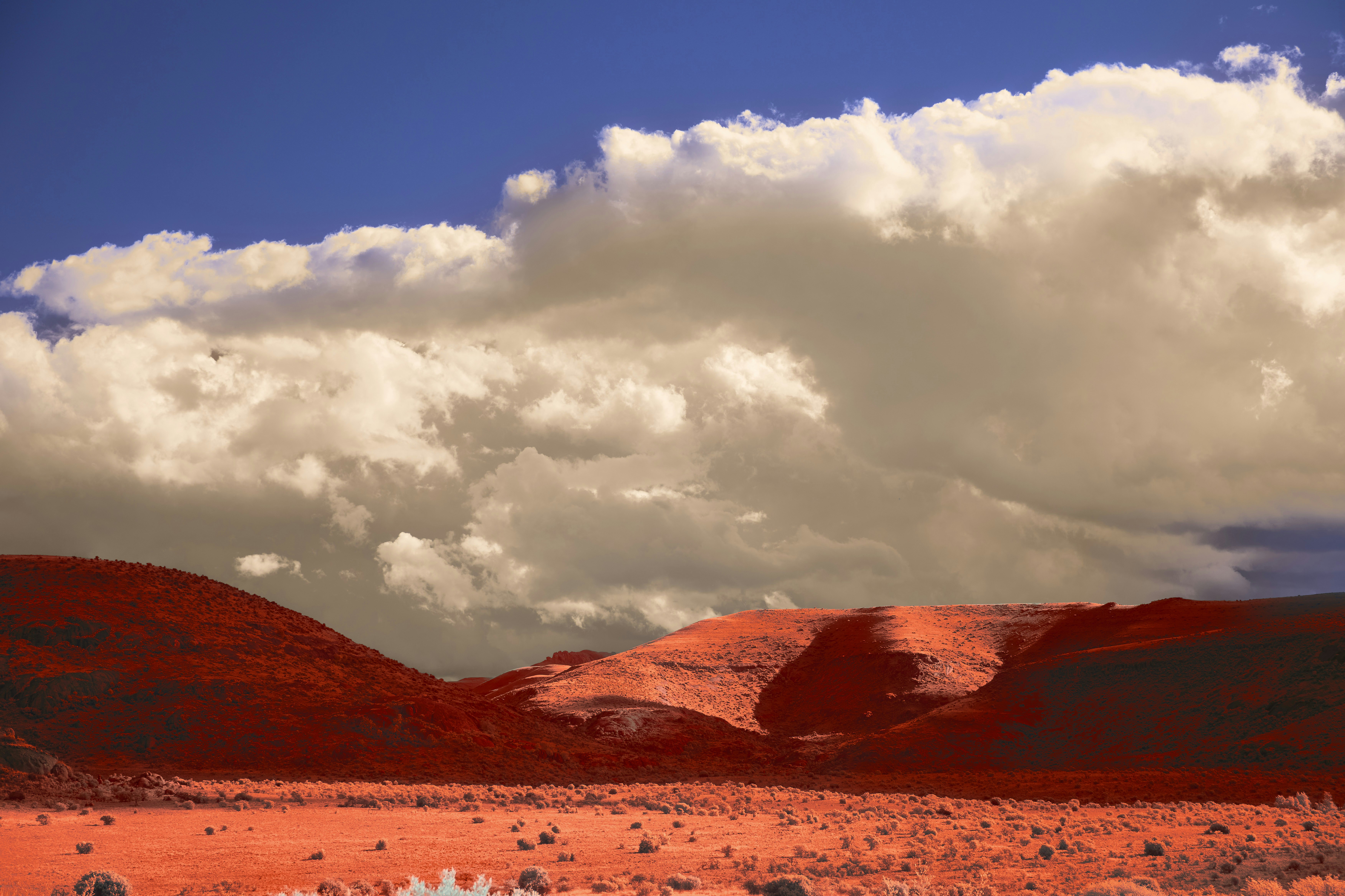 Crimson Dunes Under a Sky of Puff and Light