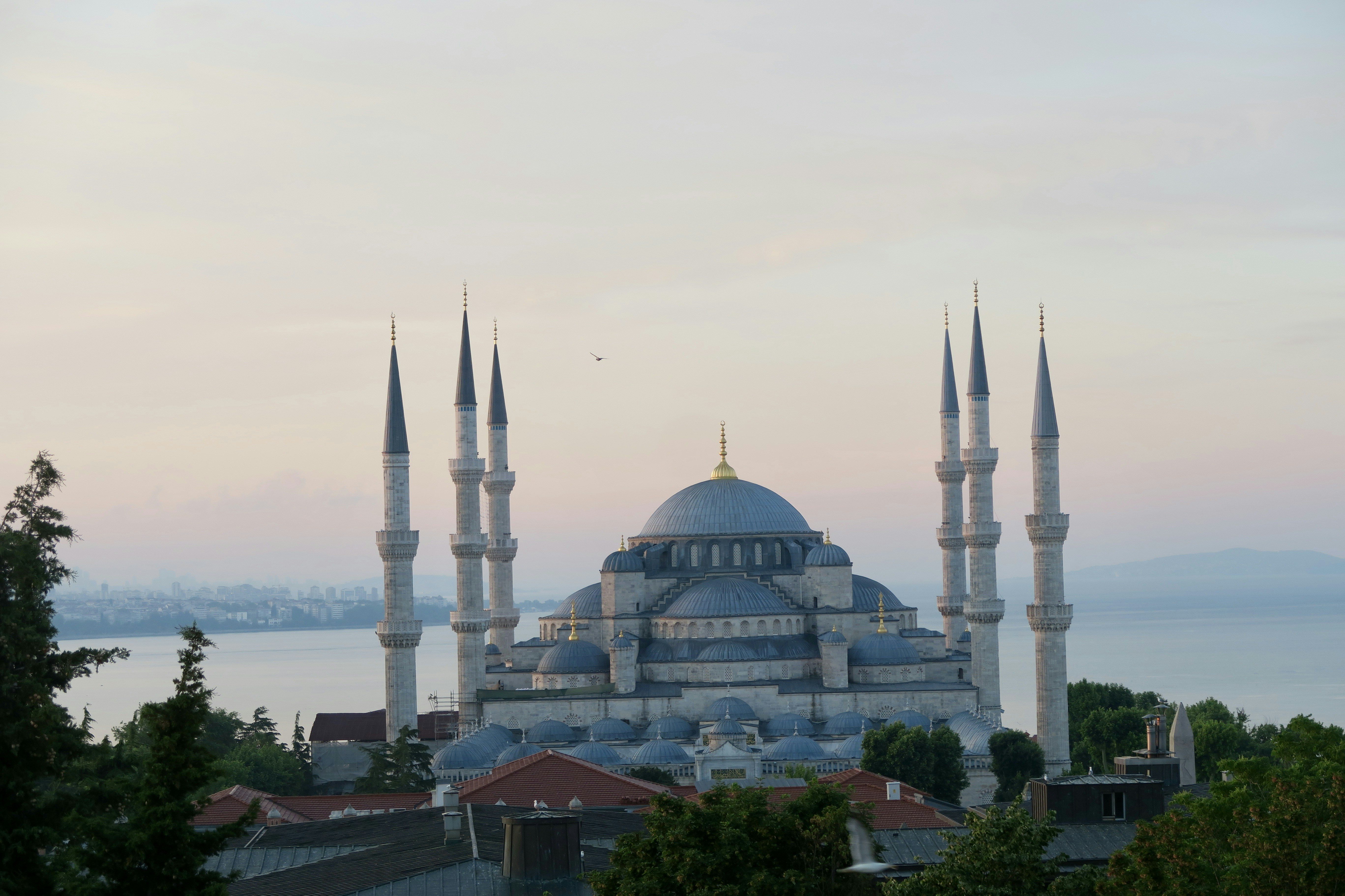 Dusky Blue Domes: A Sea-Backdropped Mosque Centered in Quiet Town