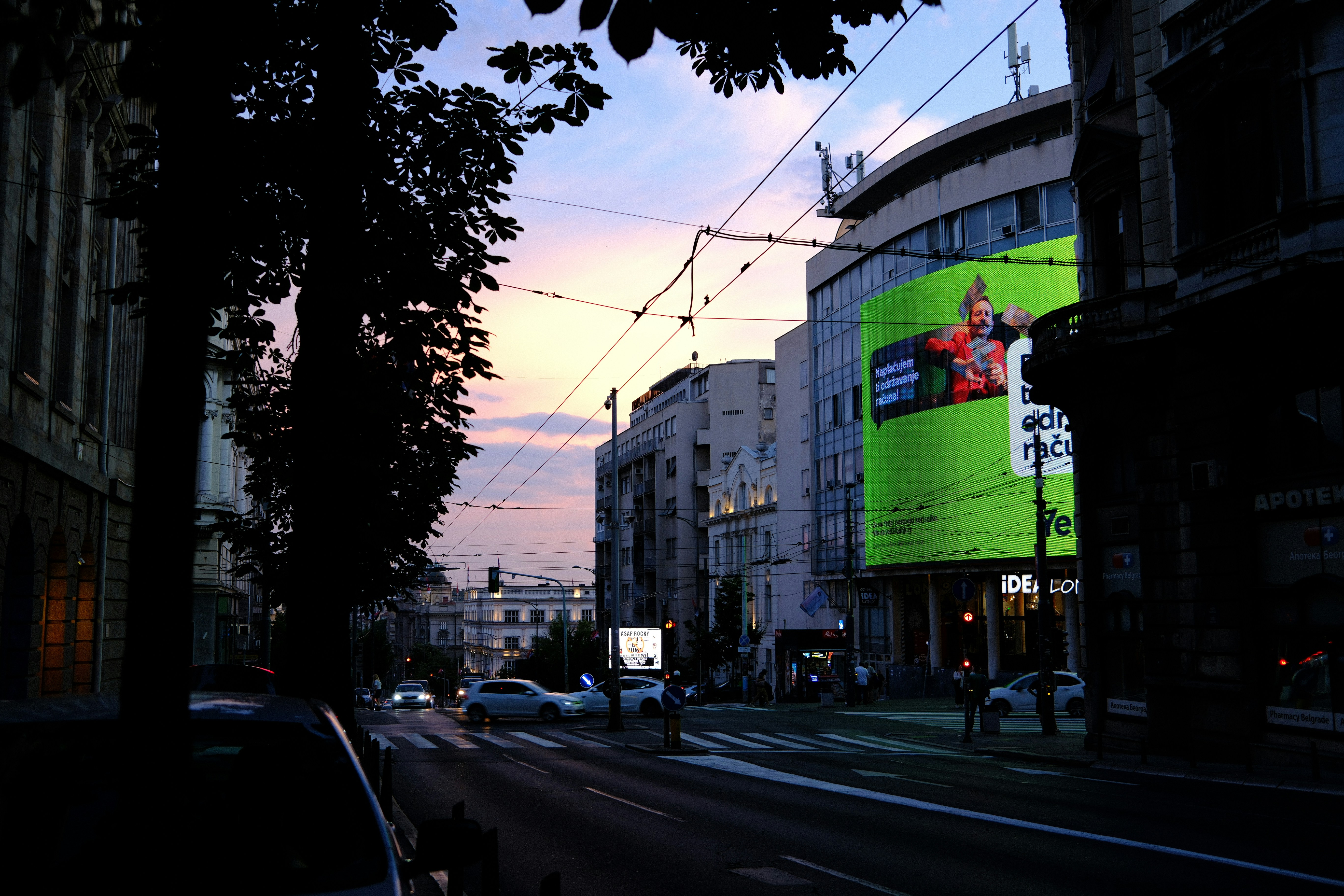 City at Dusk: Neon Billboard and Quiet Street Canyon