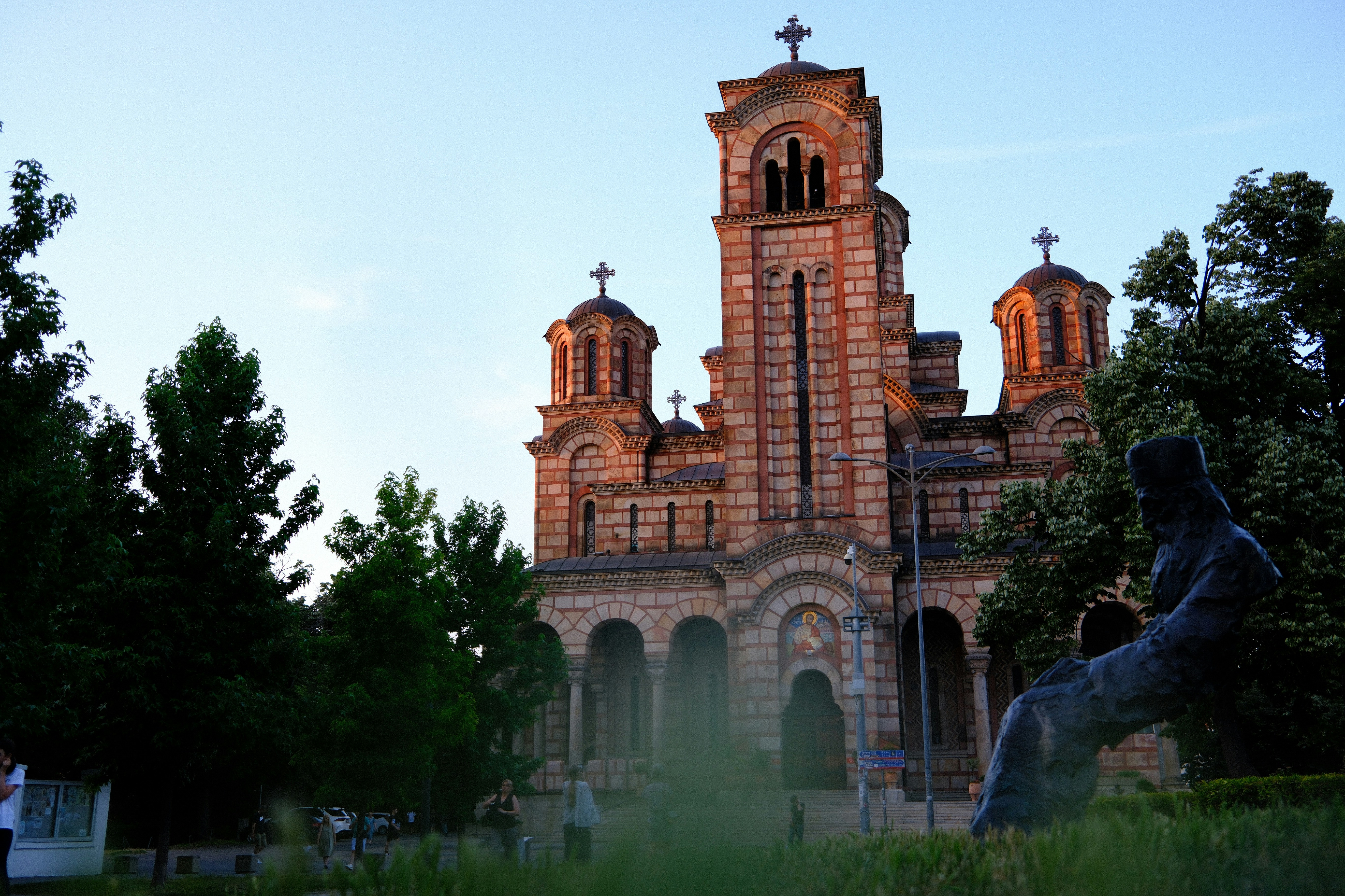 Stone Cathedral Dawn: A Solar-Illuminated Facade Rising behind a Lawn of Shadows
