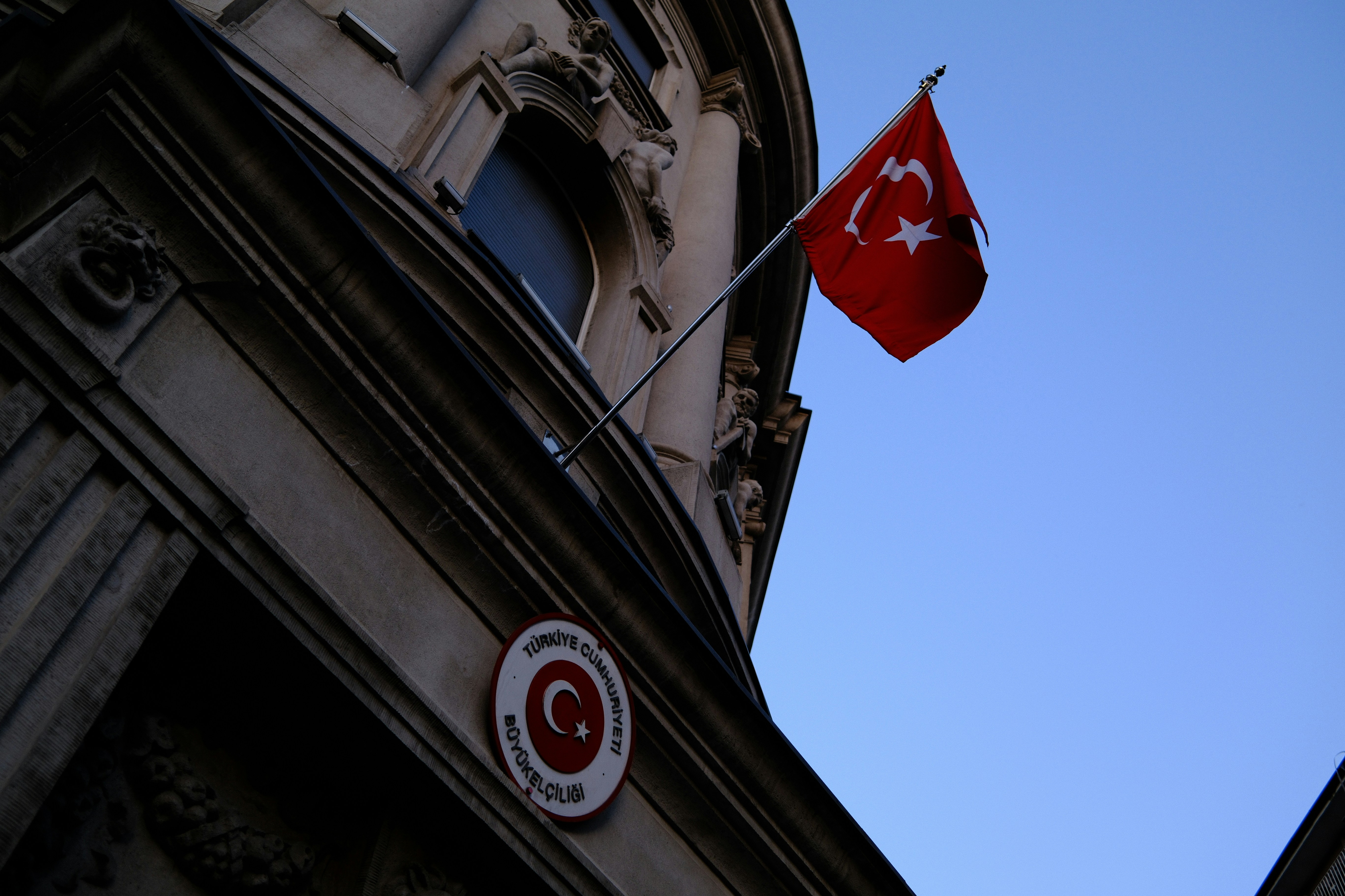 Turkish flag fluttering above a historic facade